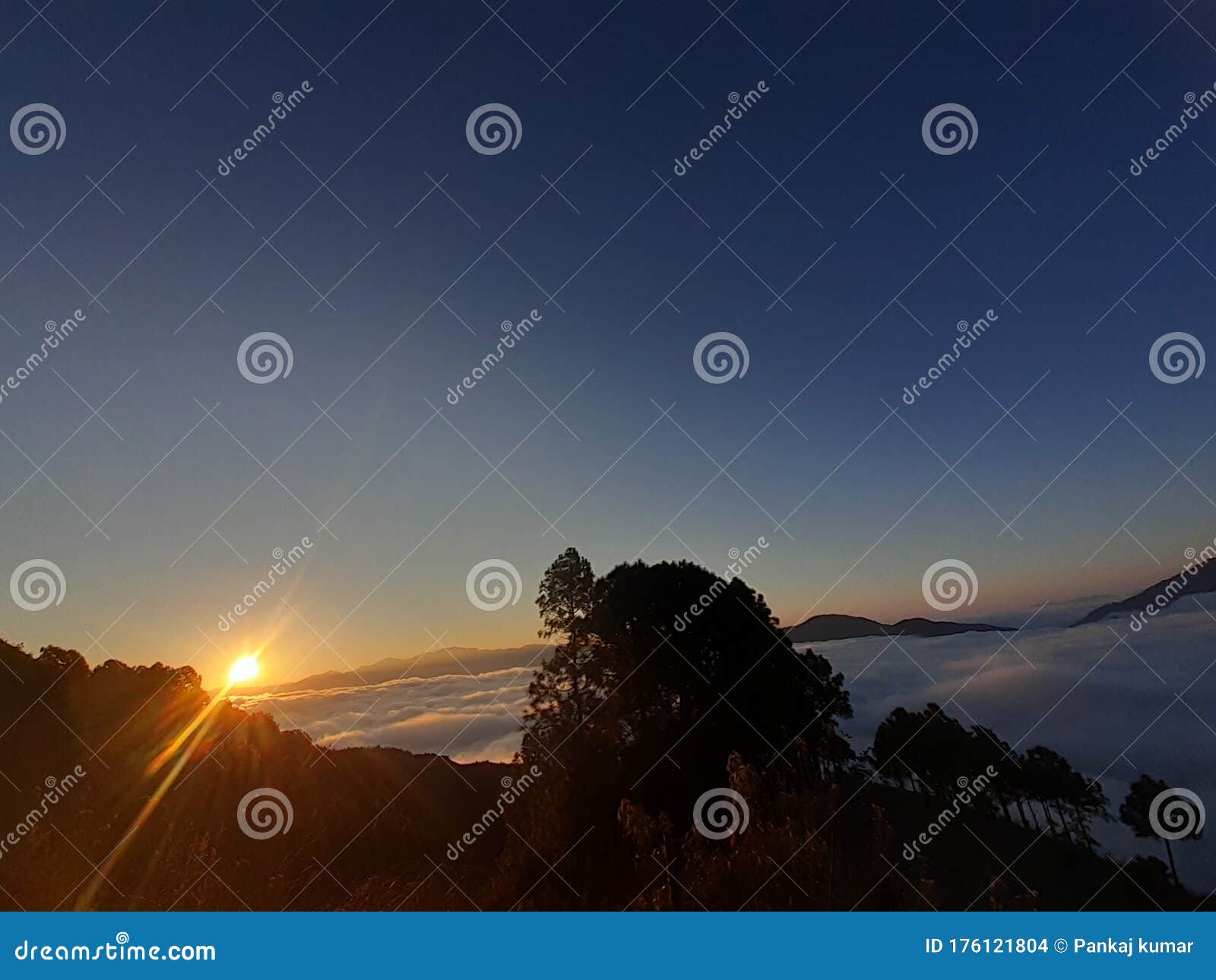 Peaceful Cloudy Sunset with Trees and Mountains. Stock Photo - Image of ...