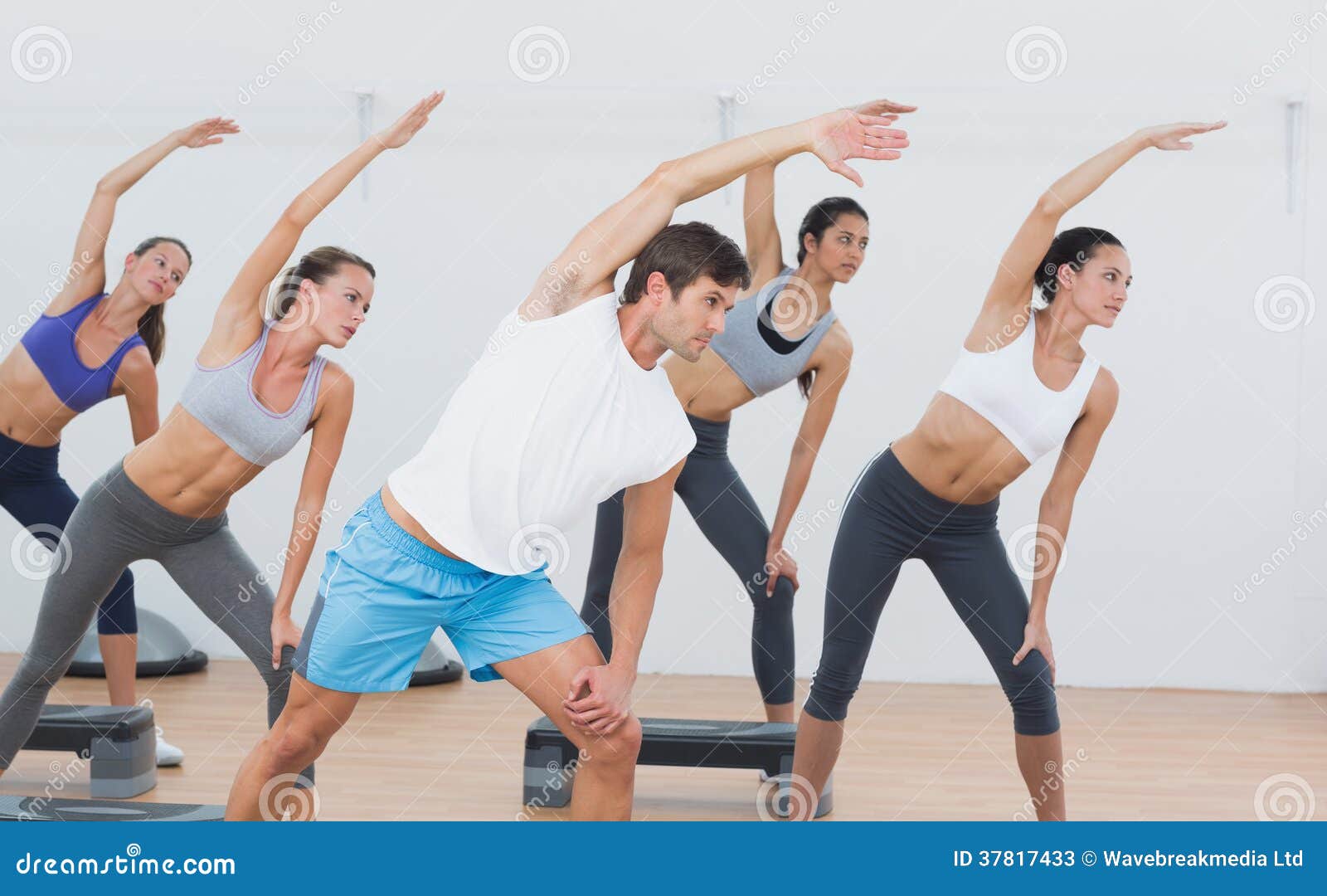 Class Doing Stretching Exercise in Fitness Studio Stock Image - Image ...