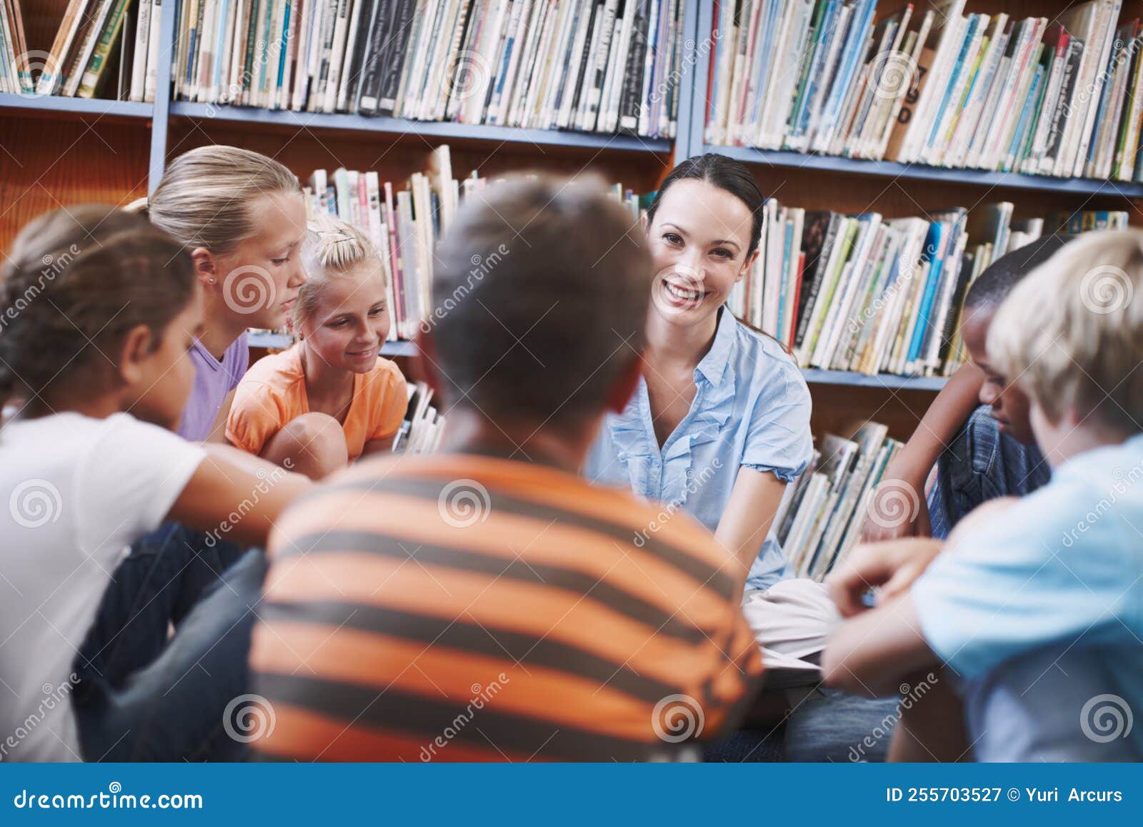 Class in the Library. a Pretty Teacher Sitting with Her Excited ...