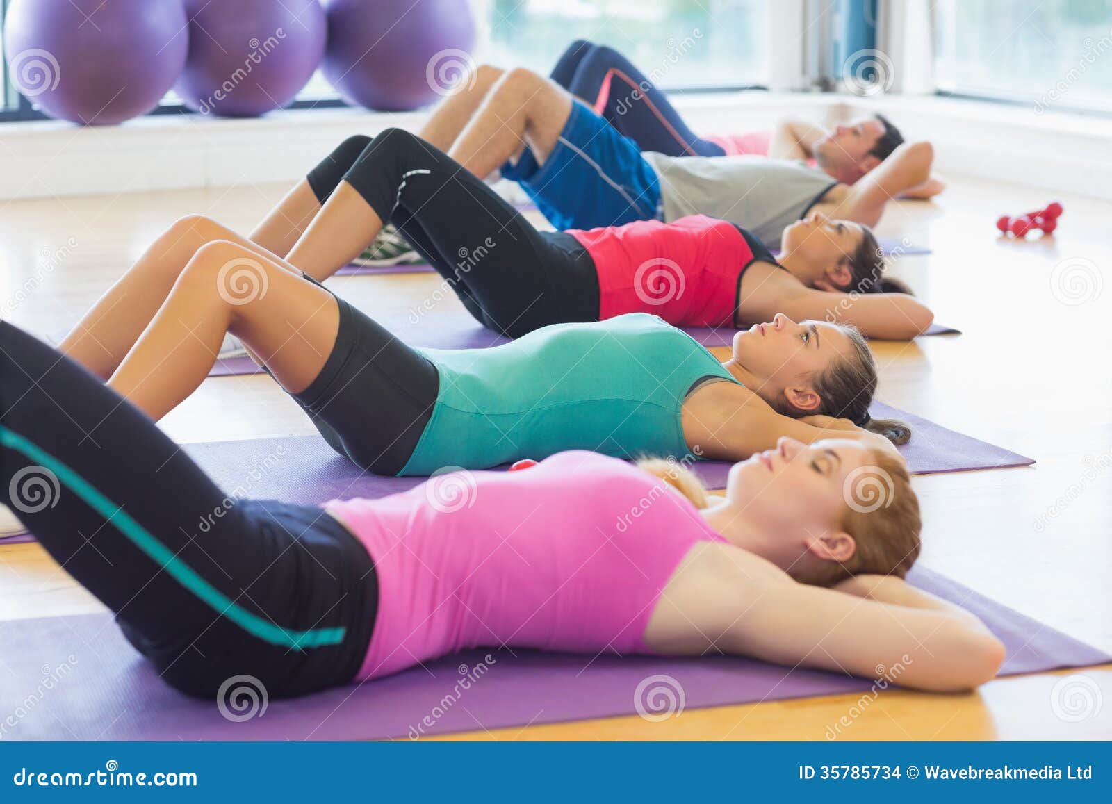 Class Lying on Exercise Mats in Row at Fitness Studio Stock Photo ...