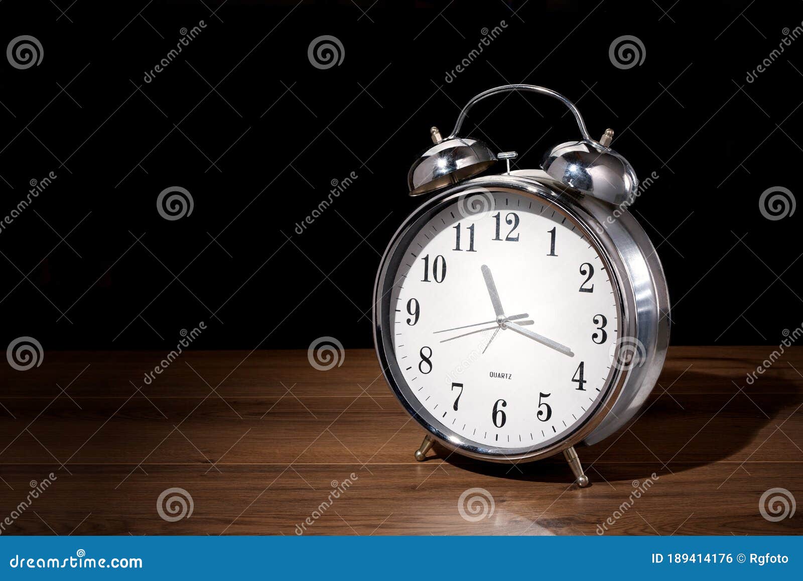 Classic Analog Alarm Clock on Wood, Dark Background with Copy Space ...