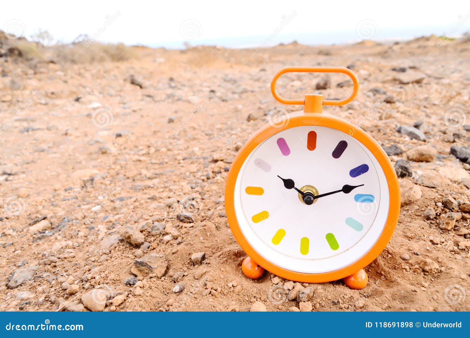 Classic Analog Clock in the Sand Stock Photo - Image of deadline ...