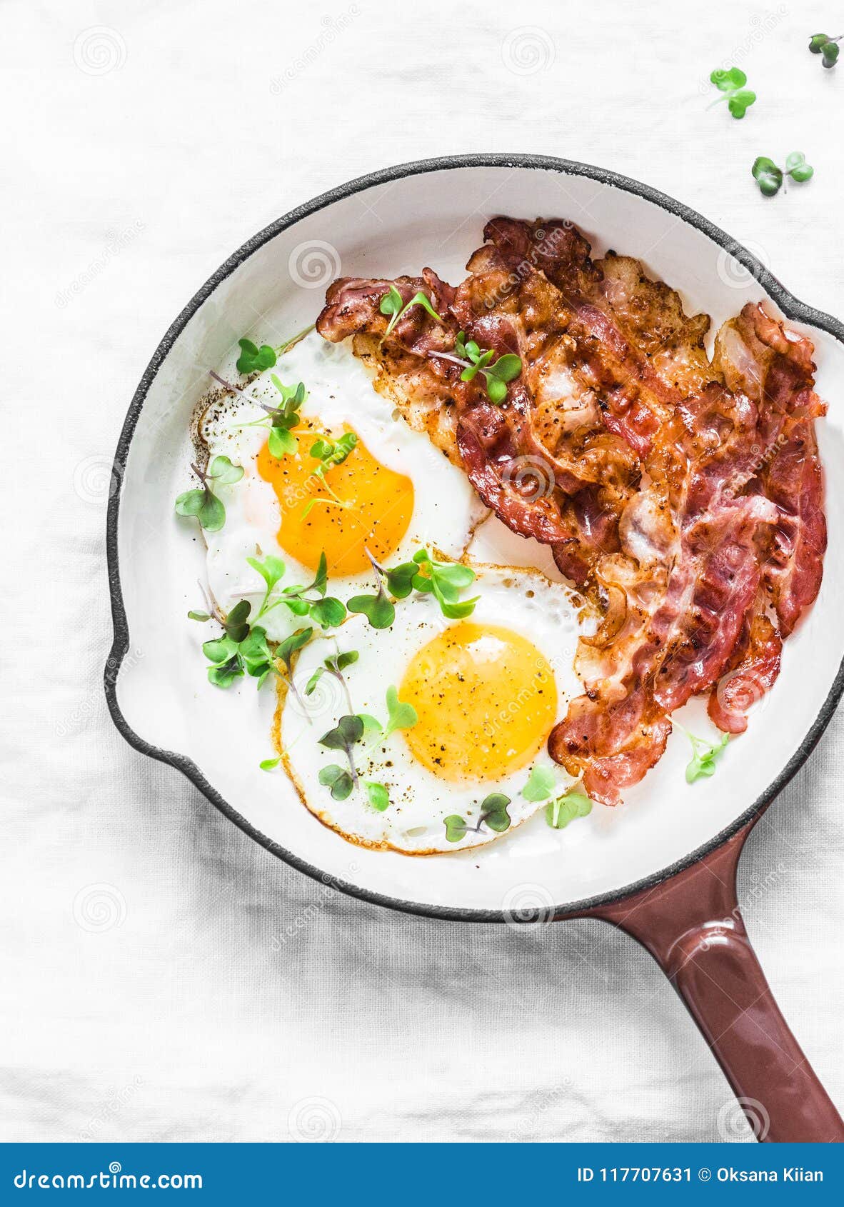Classic Breakfast - Fried Eggs and Bacon in a Cast Iron Pan on a Light ... Classic Breakfast - Fried Eggs and Bacon in a Cast Iron Pan on a Light ...