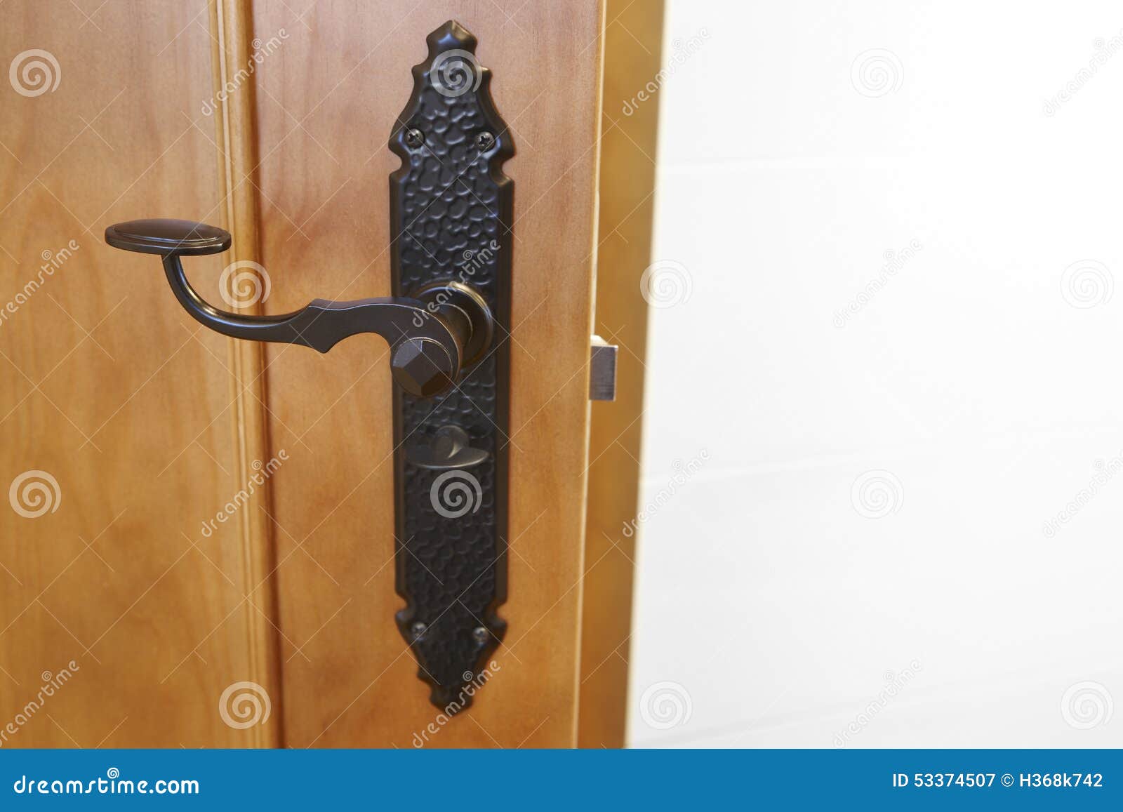 Classic Door Handle in an Open Door and White Wall Stock Image - Image ...