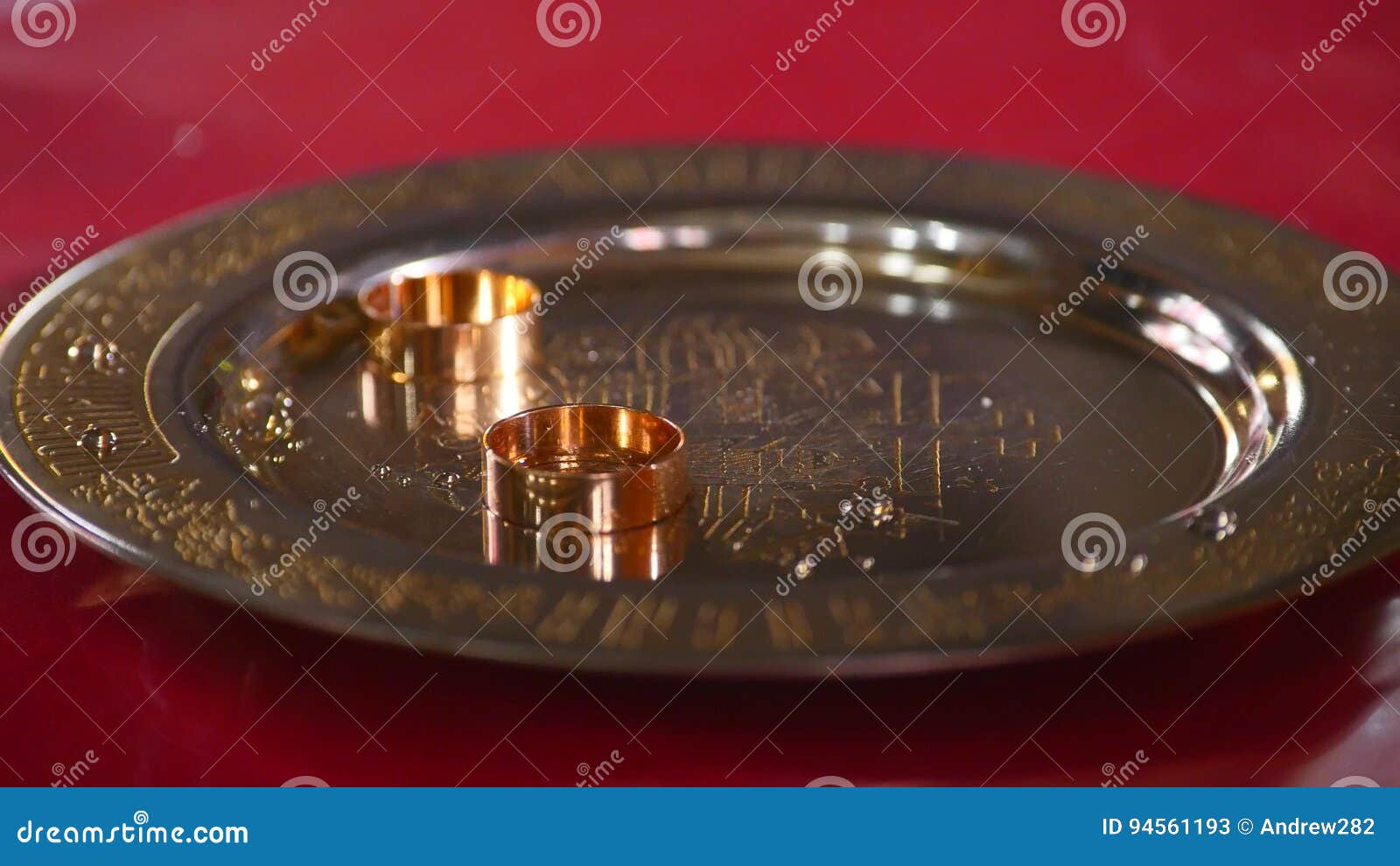 Classic Gold Wedding Ring on a Gold Plate Stock Image - Image of golden ...