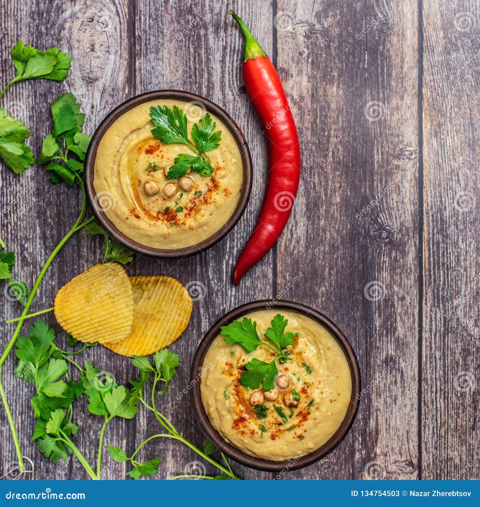Classic Hummus in Bowls on Wooden Table. Top View Stock Image - Image ...