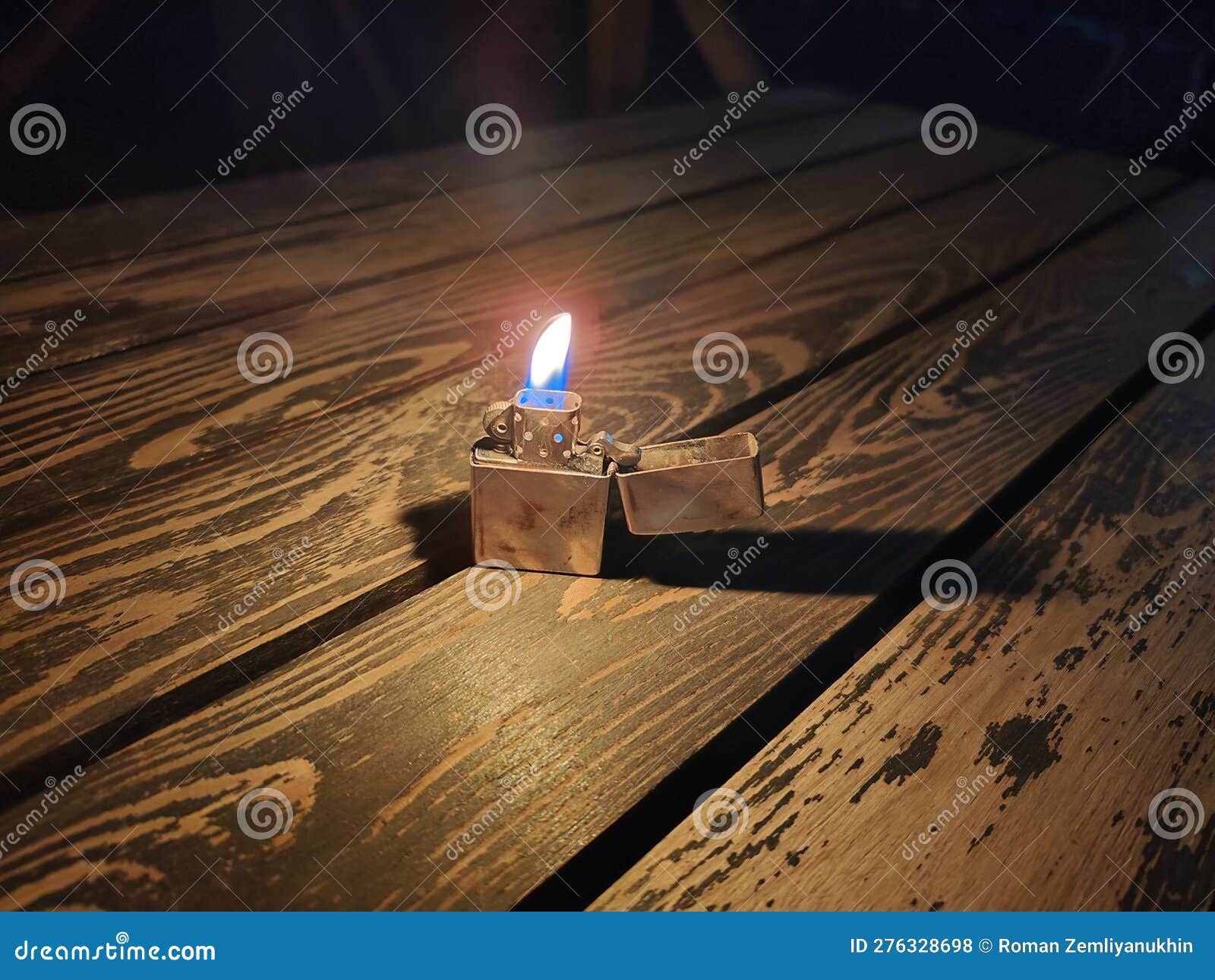 A Classic Lighter Standing on a Table in the Dark. Stock Photo - Image ...