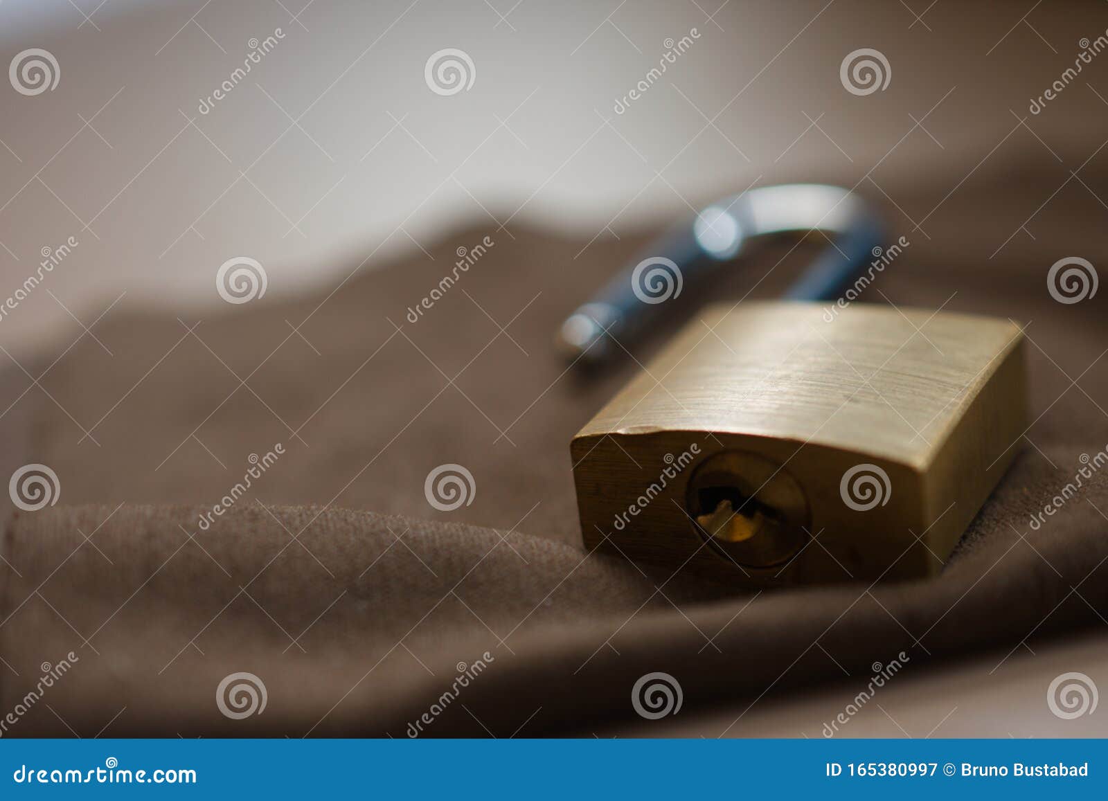 Classic Padlock Open, Vintage-looking Style, with a Brown Cloth Behind ...