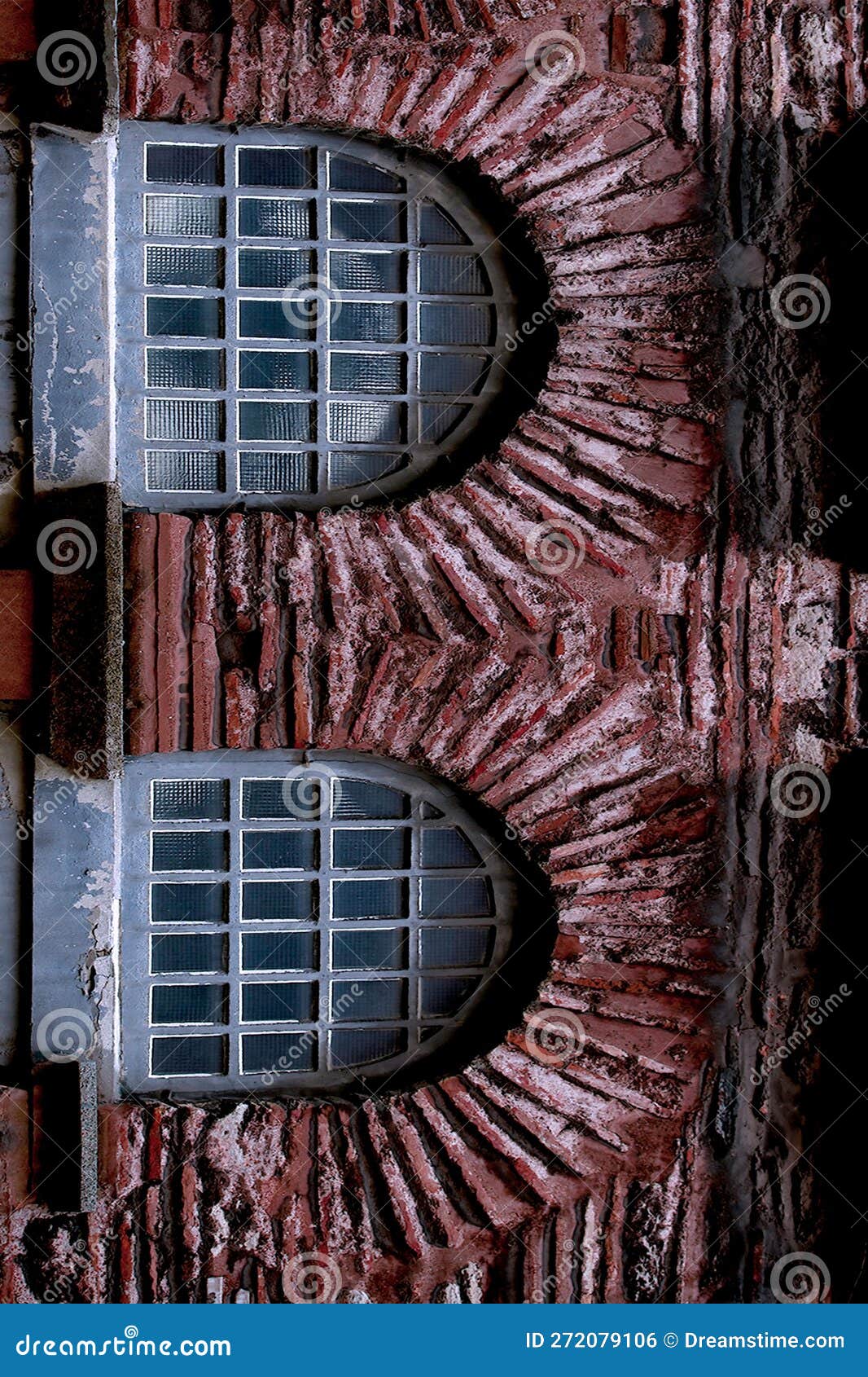 Classic Red Brick Building Featuring Two Barred Windows with an Arched ...