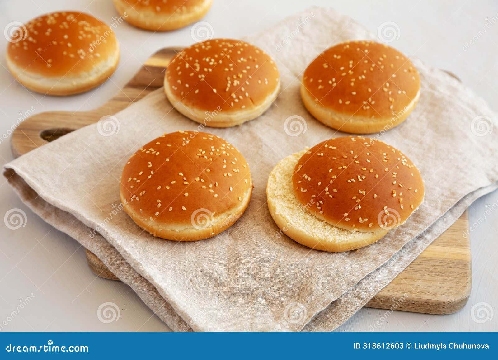 Classic Sesame Seed Hamburger Buns on a Wooden Board, Side View Stock ...