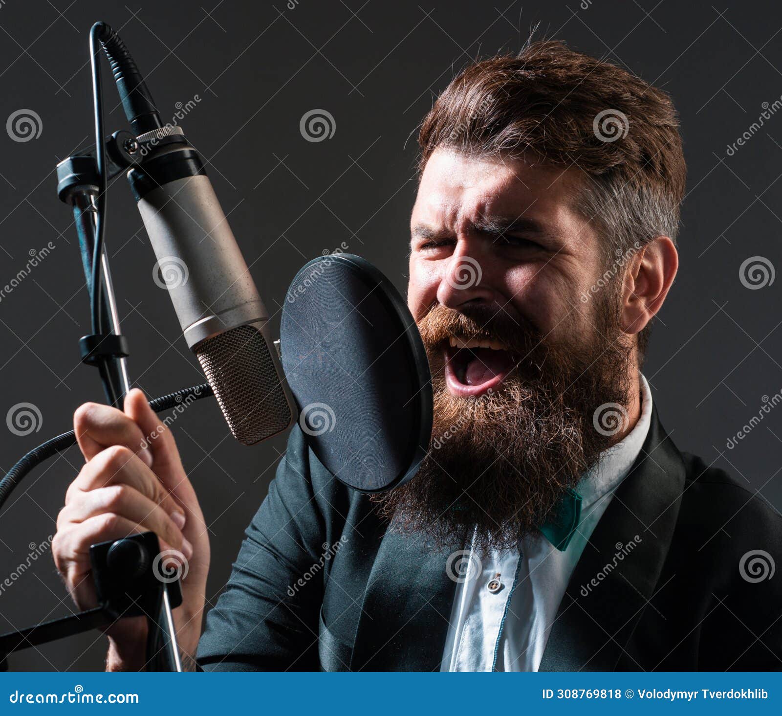 Classic Singer is Performing a Song with a Microphone while Recording ...