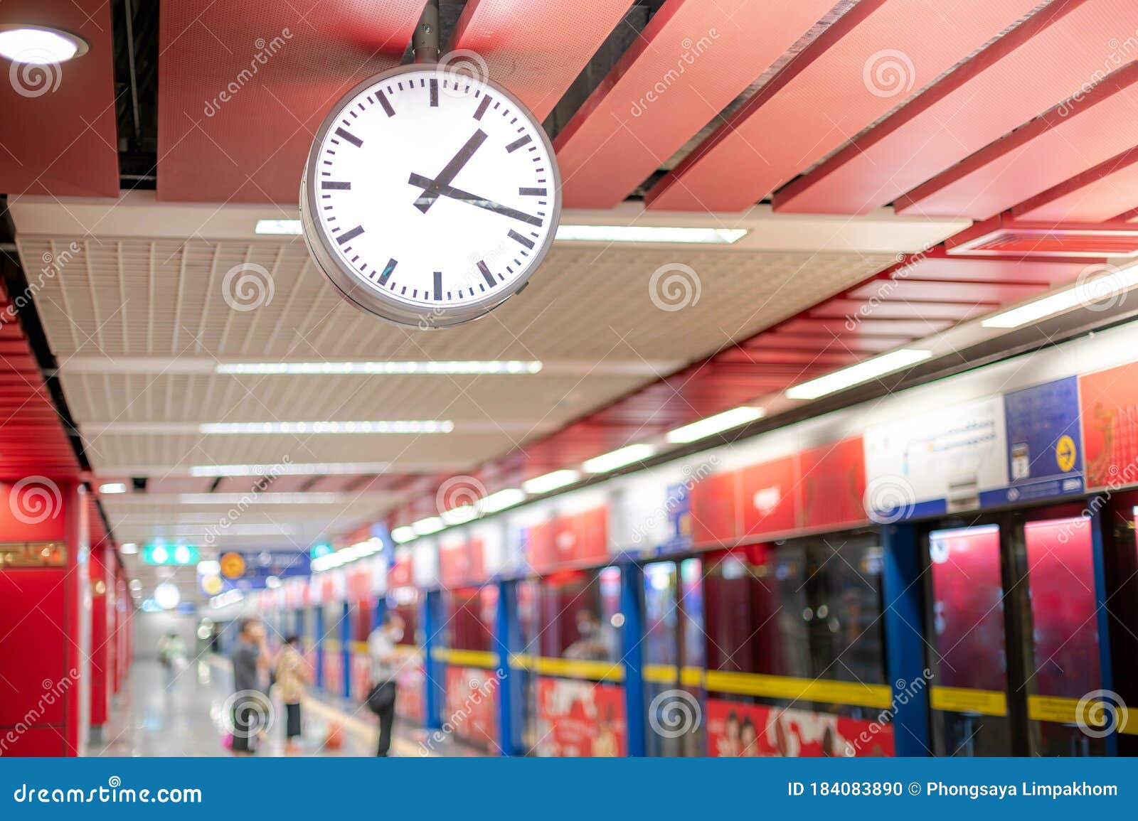 A Classic White Digital Clock and Escape Exit Sign Hang from the ...