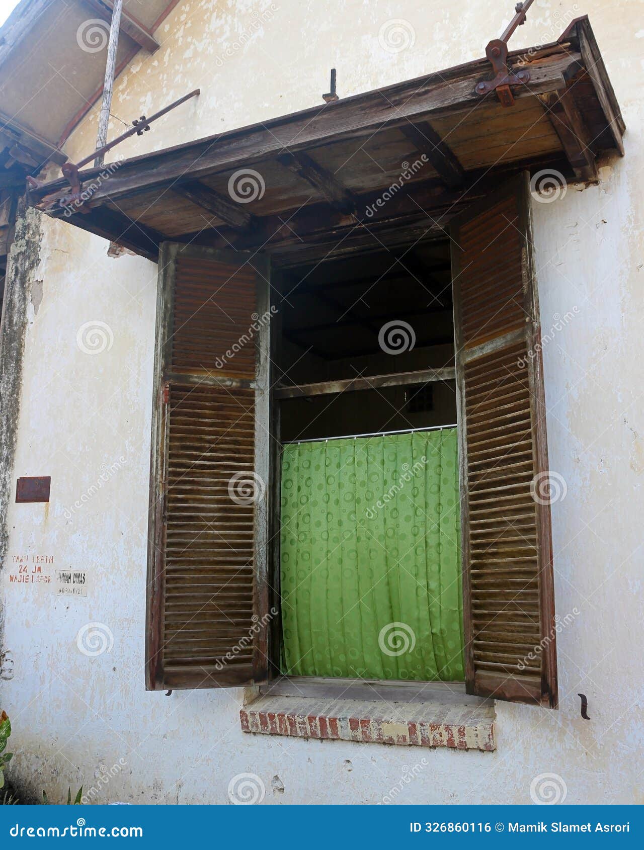 A Classic Wooden Window with a Canopy and Green Curtains Stock Photo ...