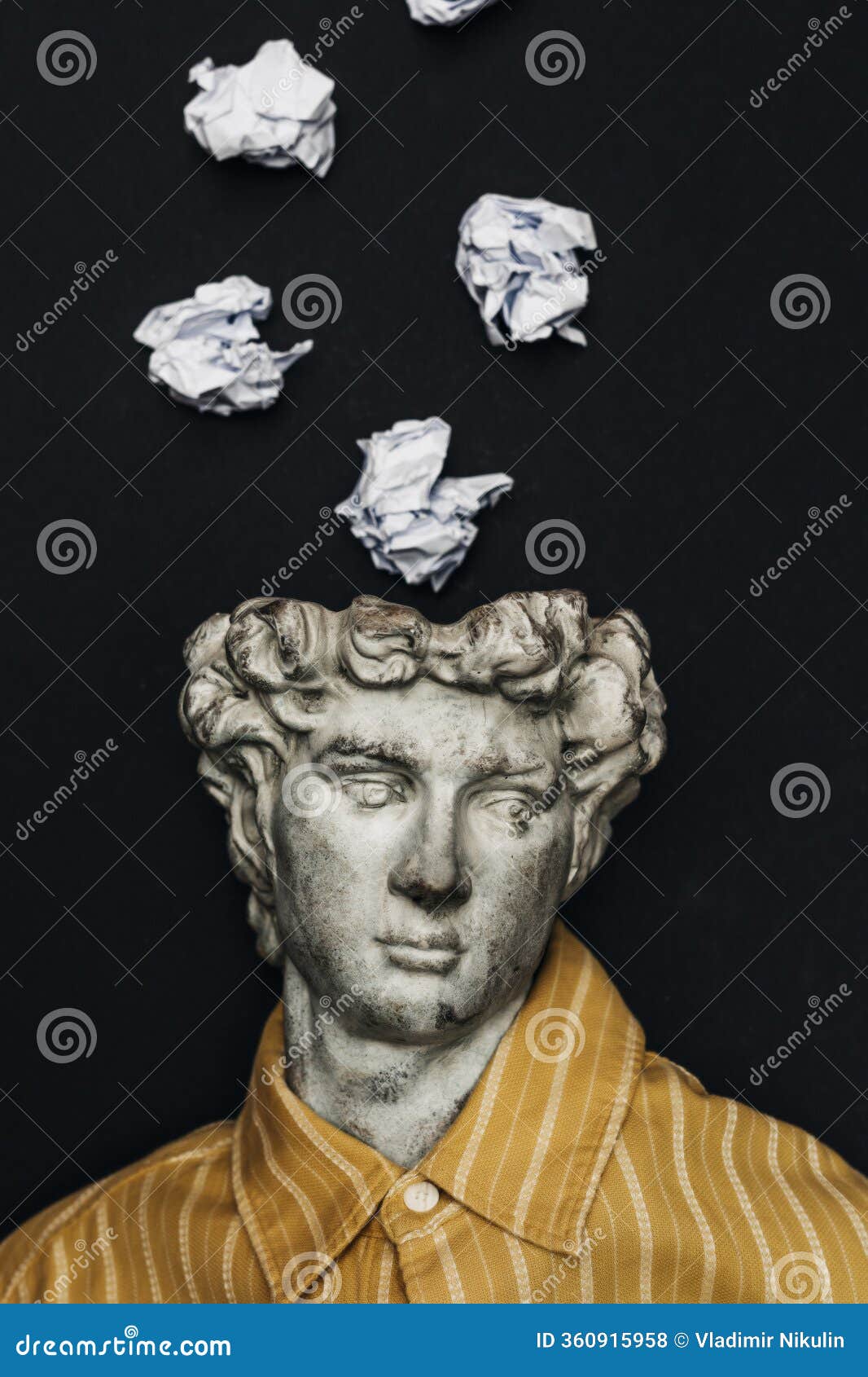 Classical Bust Statue Alongside a Sheet of Paper and Crumpled Paper on ...