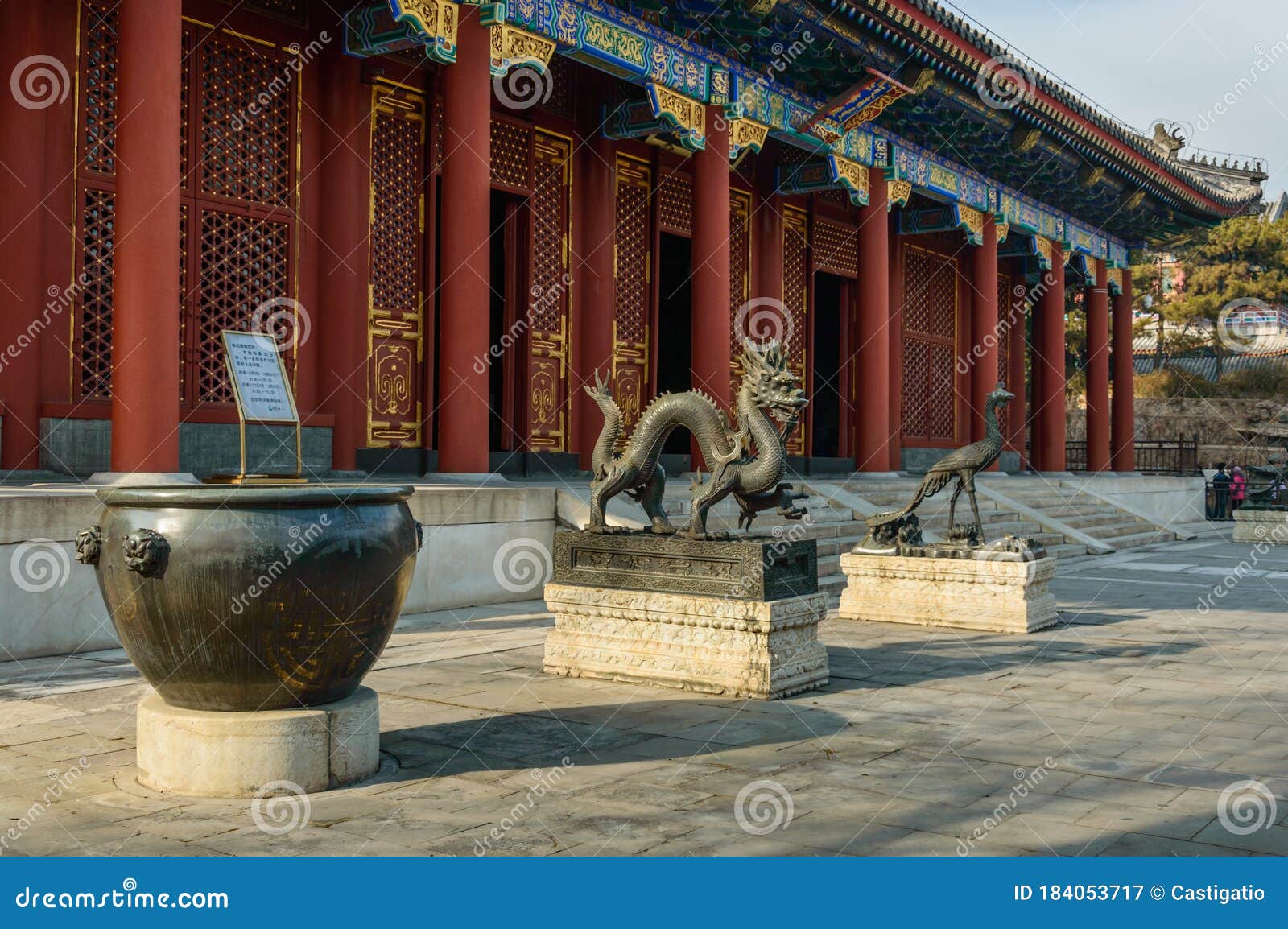 Classical Chinese Sculptures Stand in Front of a Colorful Old Building ...