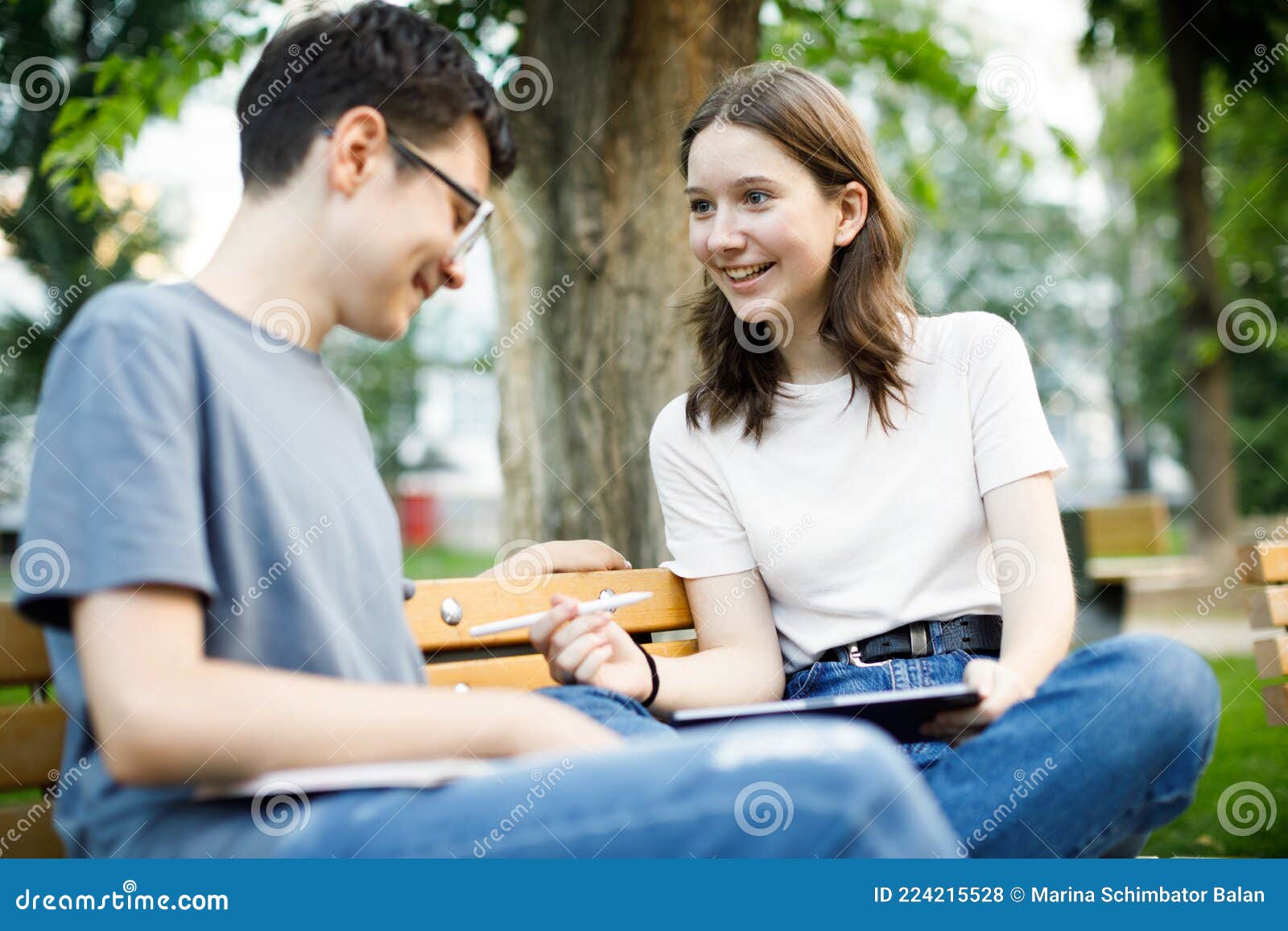 Classmates Talking on a Bench of the School Yard Stock Photo - Image of ...
