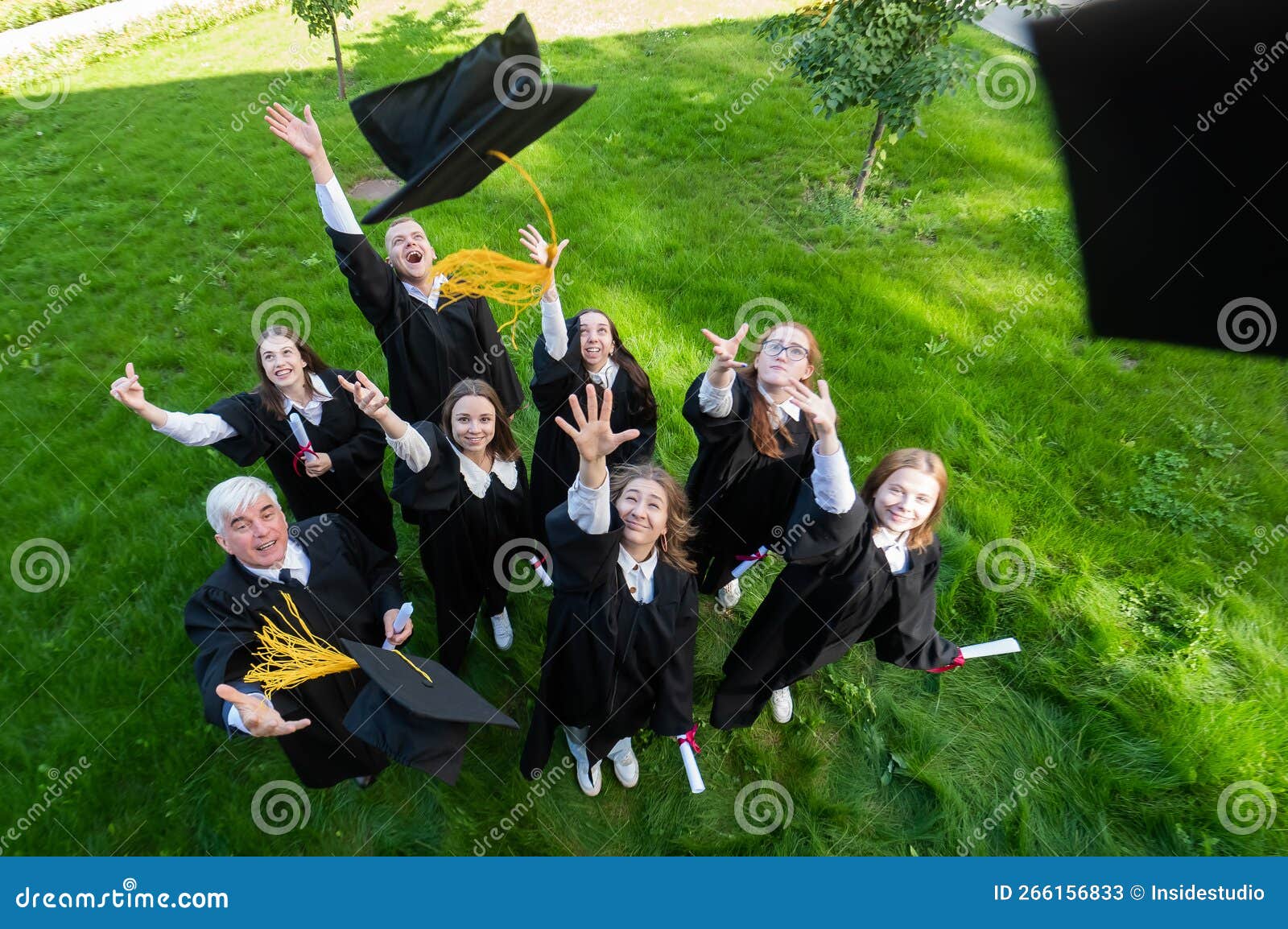 Classmates in Graduation Gowns Throw Their Caps. View from Above. Stock ...