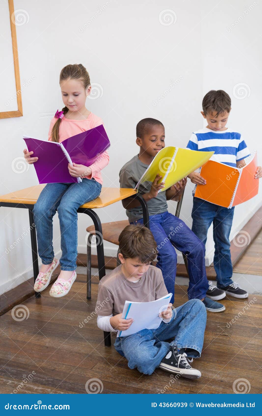 Classmates Reading from Notepads in Classroom Stock Image - Image of ...