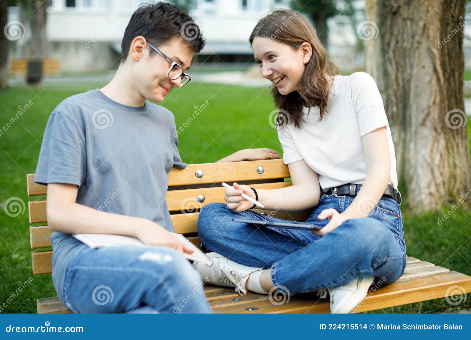 Classmates Talking on a Bench of the School Yard Stock Photo - Image of ...