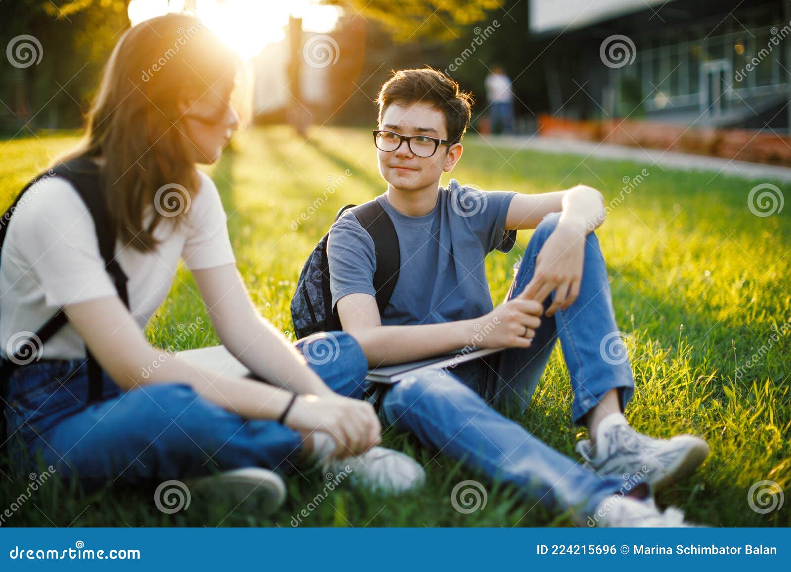 Classmates Talking on the Grass of the School Yard Stock Photo - Image ...