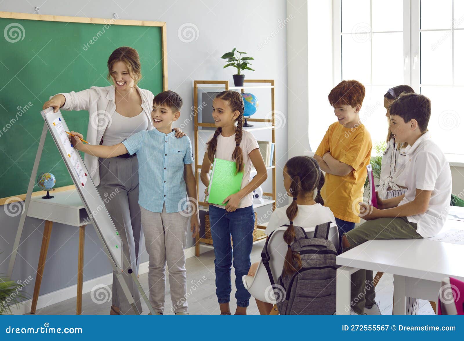 Elementary School Students Use Whiteboard Together with the Teacher ...