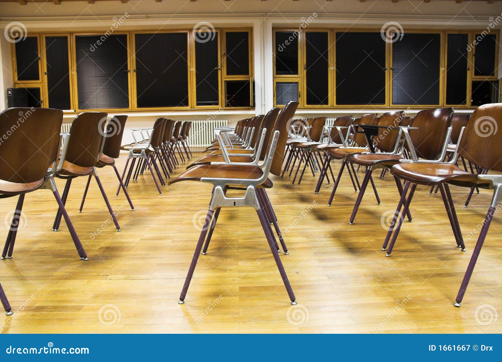 Lit Classroom With Rows Of Wooden Tables For Royalty-Free Stock ...