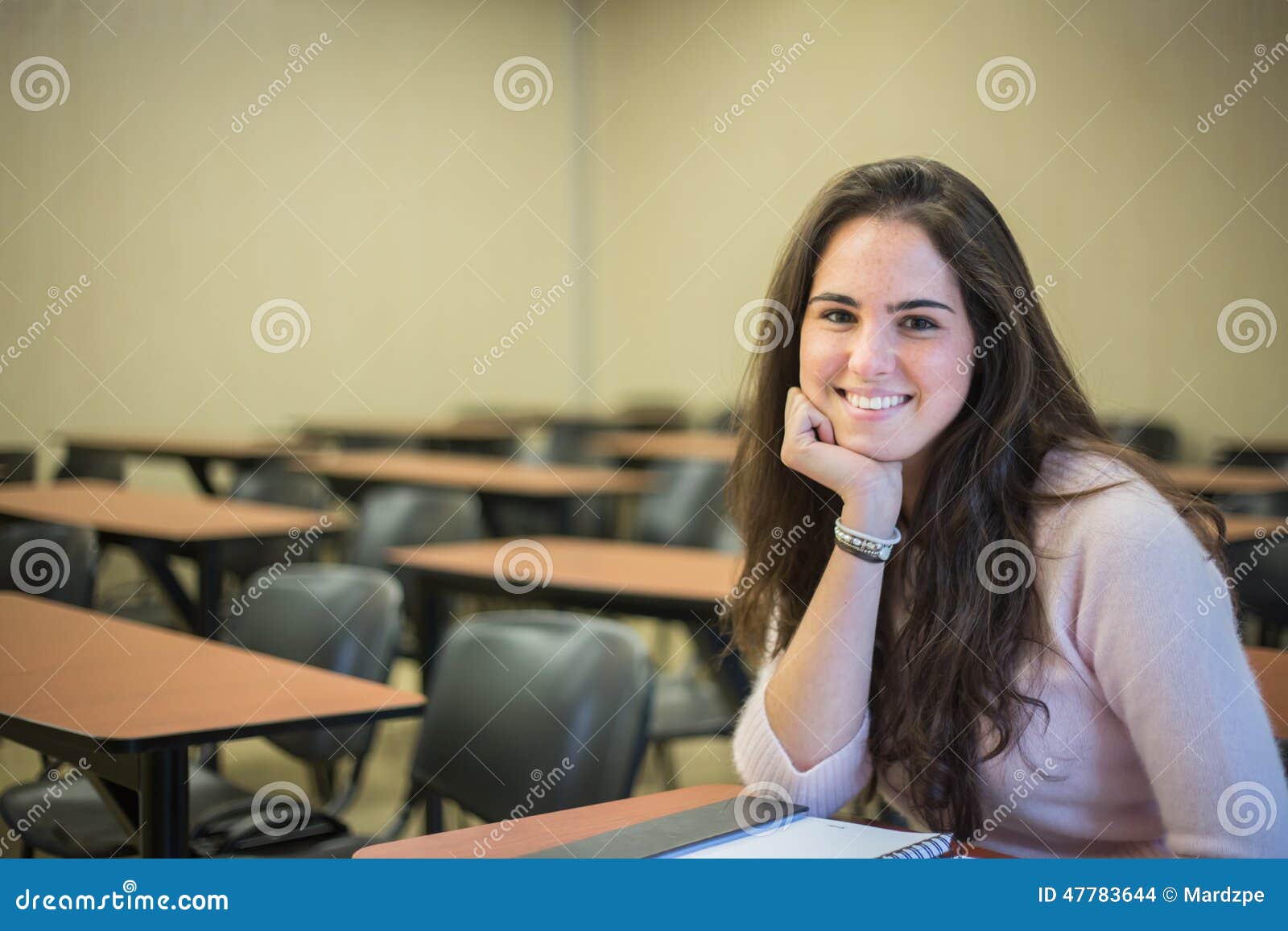 In the Classroom - Pretty Female Student with Books Working in a Stock ...