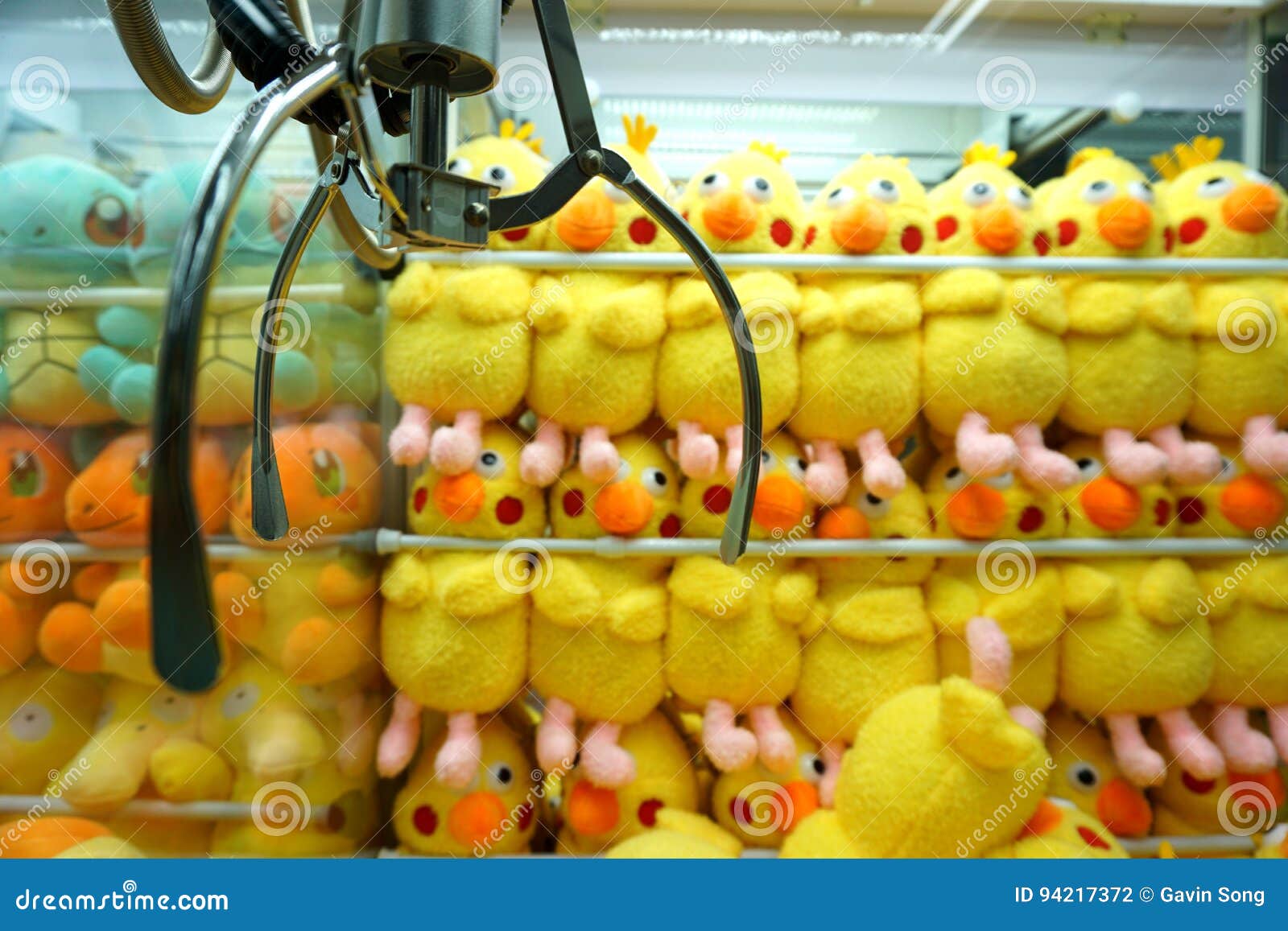 A Claw Machine are Filled with Yellow Plush Toys Stock Photo - Image of ...
