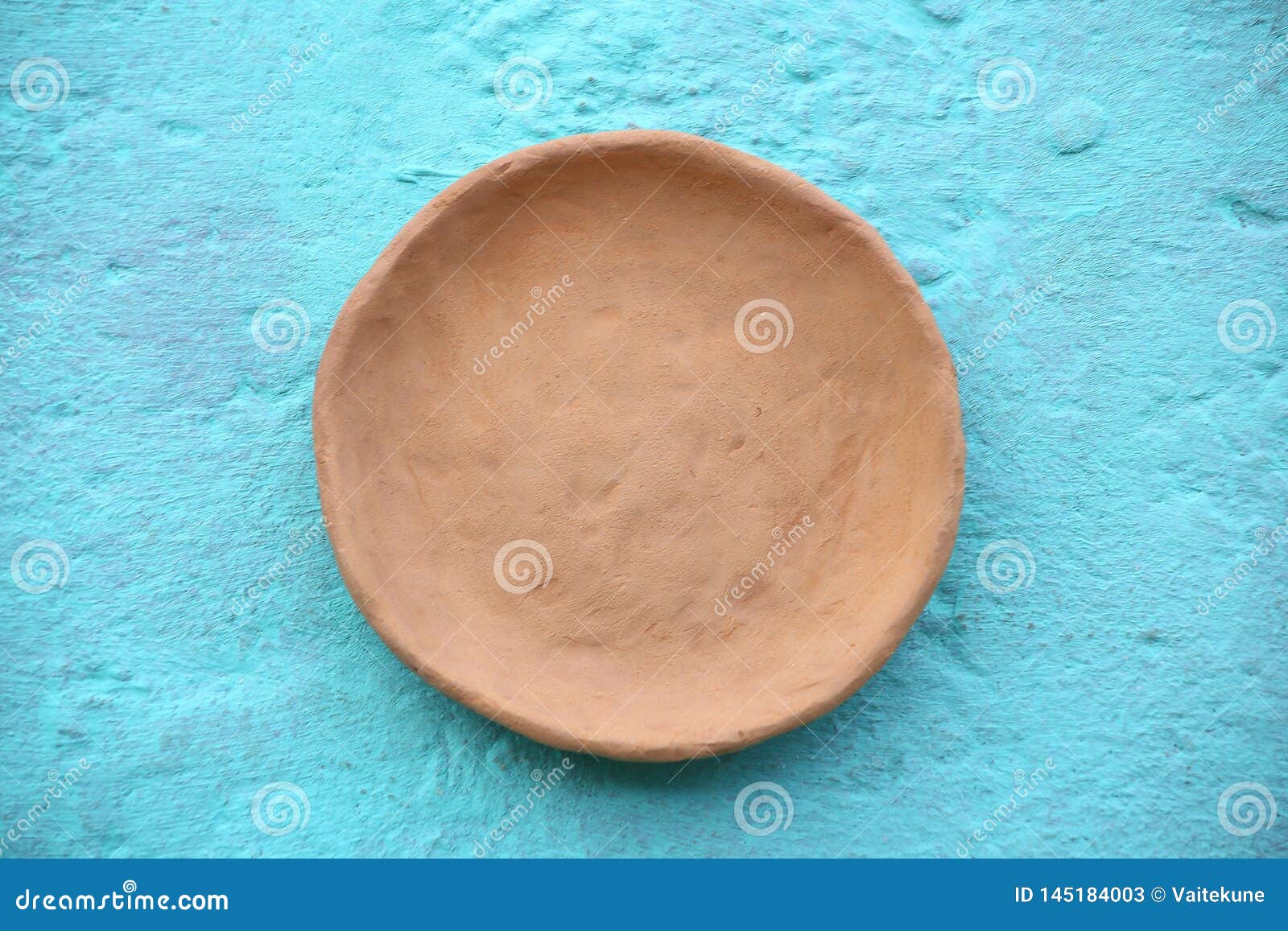Clay Plate on Blue Concrete Surface. Stock Image - Image of frame ...