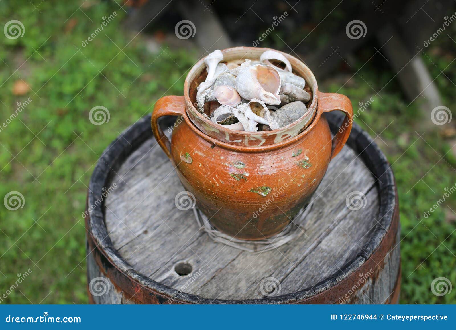 Clay Pot Filled with Empty Sea Snails Shells on a Rusty Old Barr Stock ...