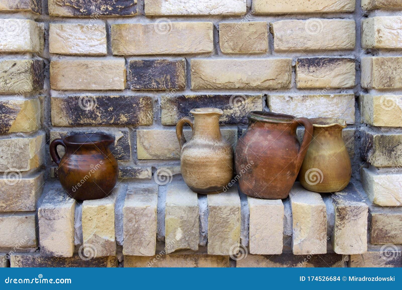 Clay pots on a brick wall stock photo. Image of oldfashioned - 174526684