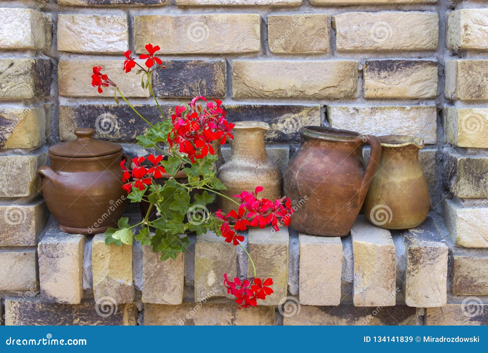 Clay pots on a brick wall stock image. Image of artistic - 134141839