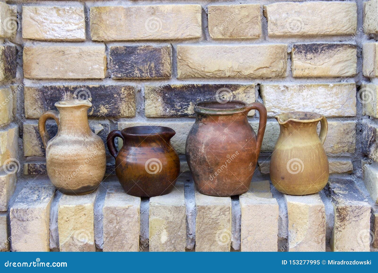 Clay pots on a brick wall stock image. Image of ceramic - 153277995