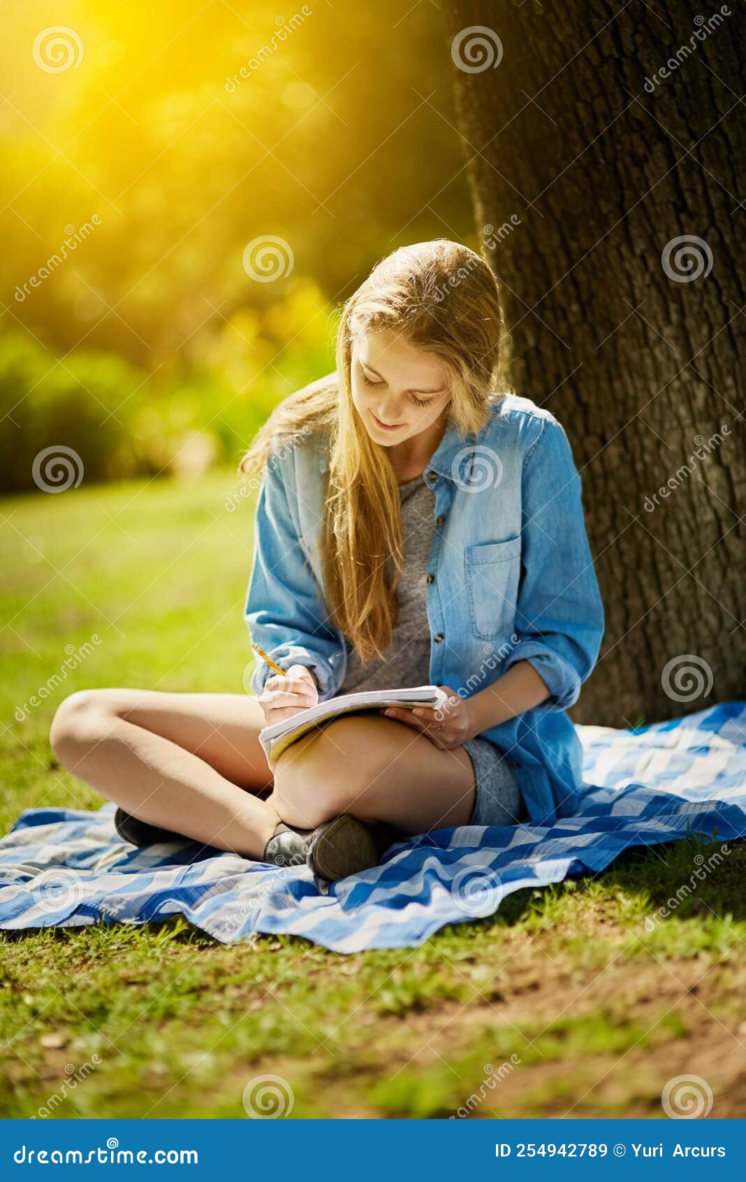Clean Air Can Do You Good. a Young Student Studying Underneath a Tree ...