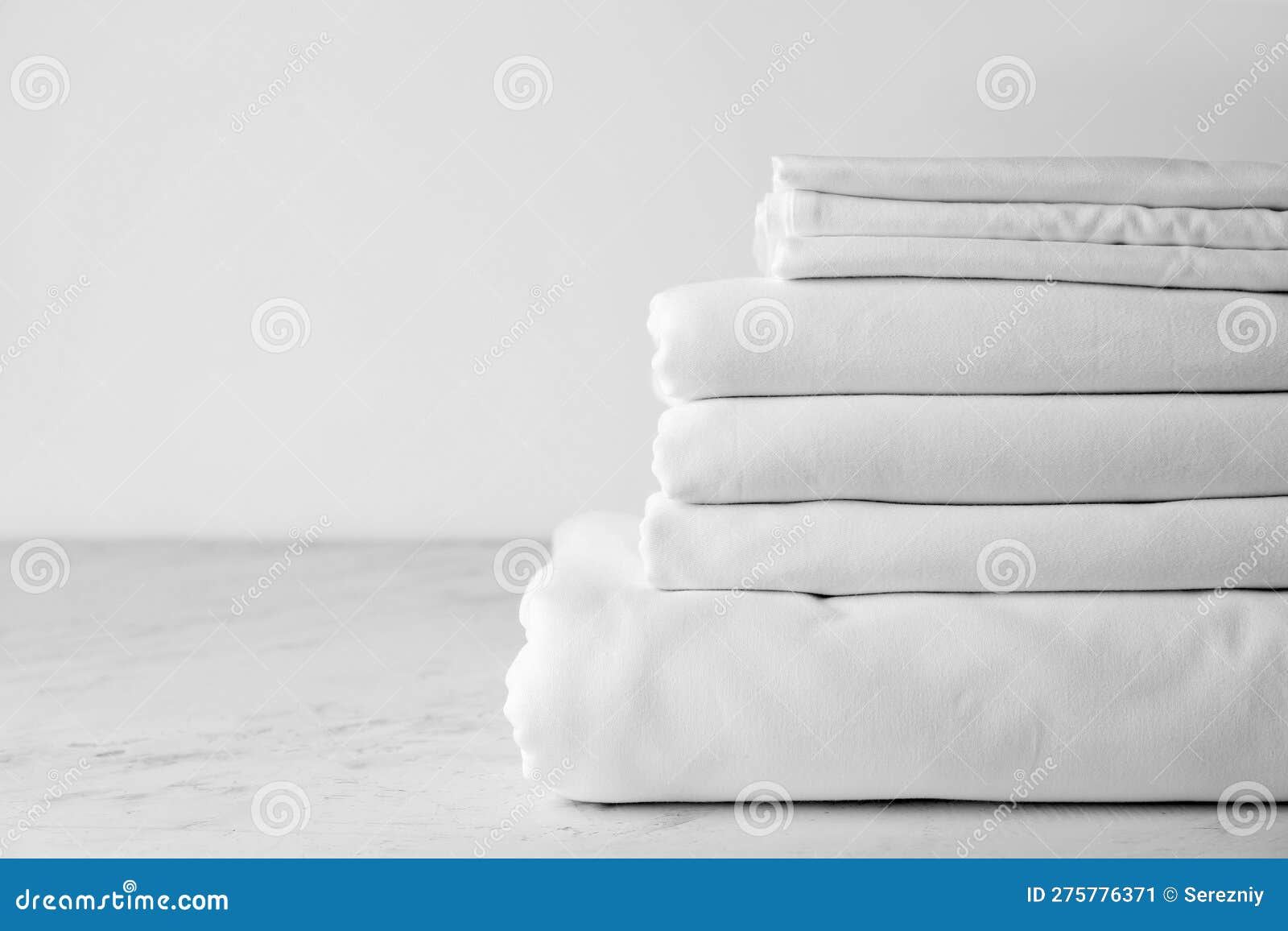 Stack of Clean Bed Sheets on Table Stock Image - Image of bedding ...