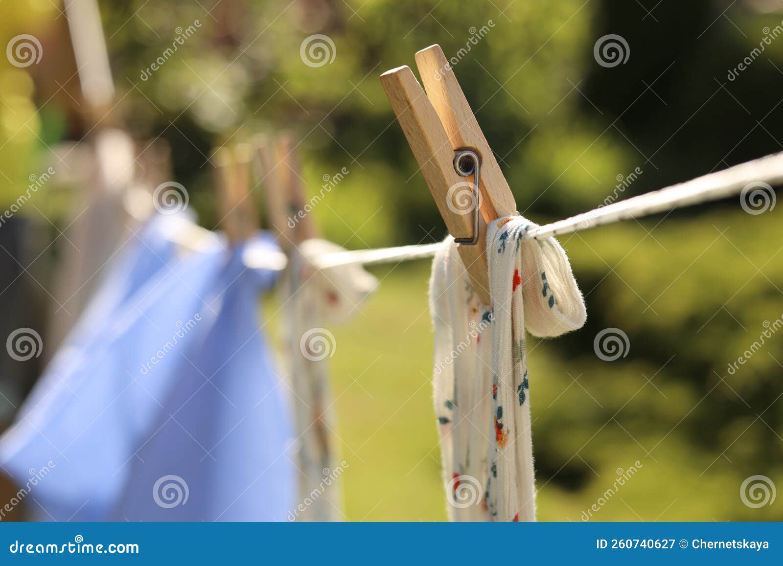 Clean Clothes Drying in Garden, Closeup. Focus on Clothespin Stock ...
