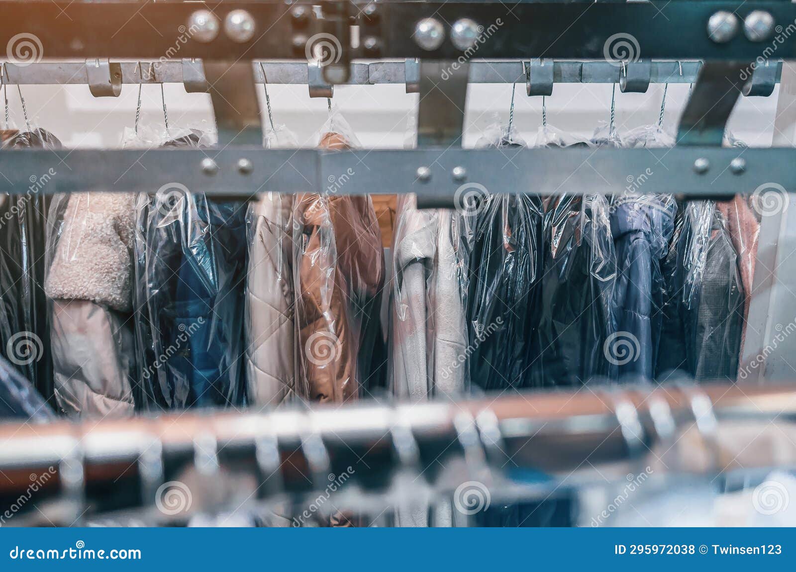 Clean Clothes on Hangers in the Dry Cleaners. Conveyor with Hangers of ...
