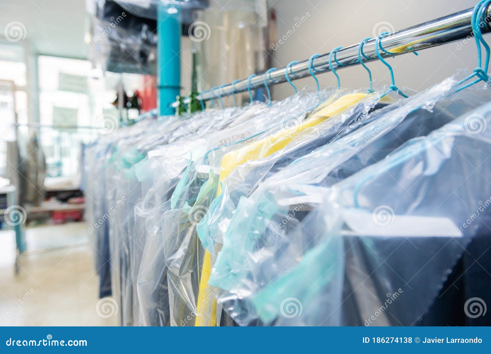 Clean Clothes on Hangers in the Laundry Room Stock Photo - Image of ...