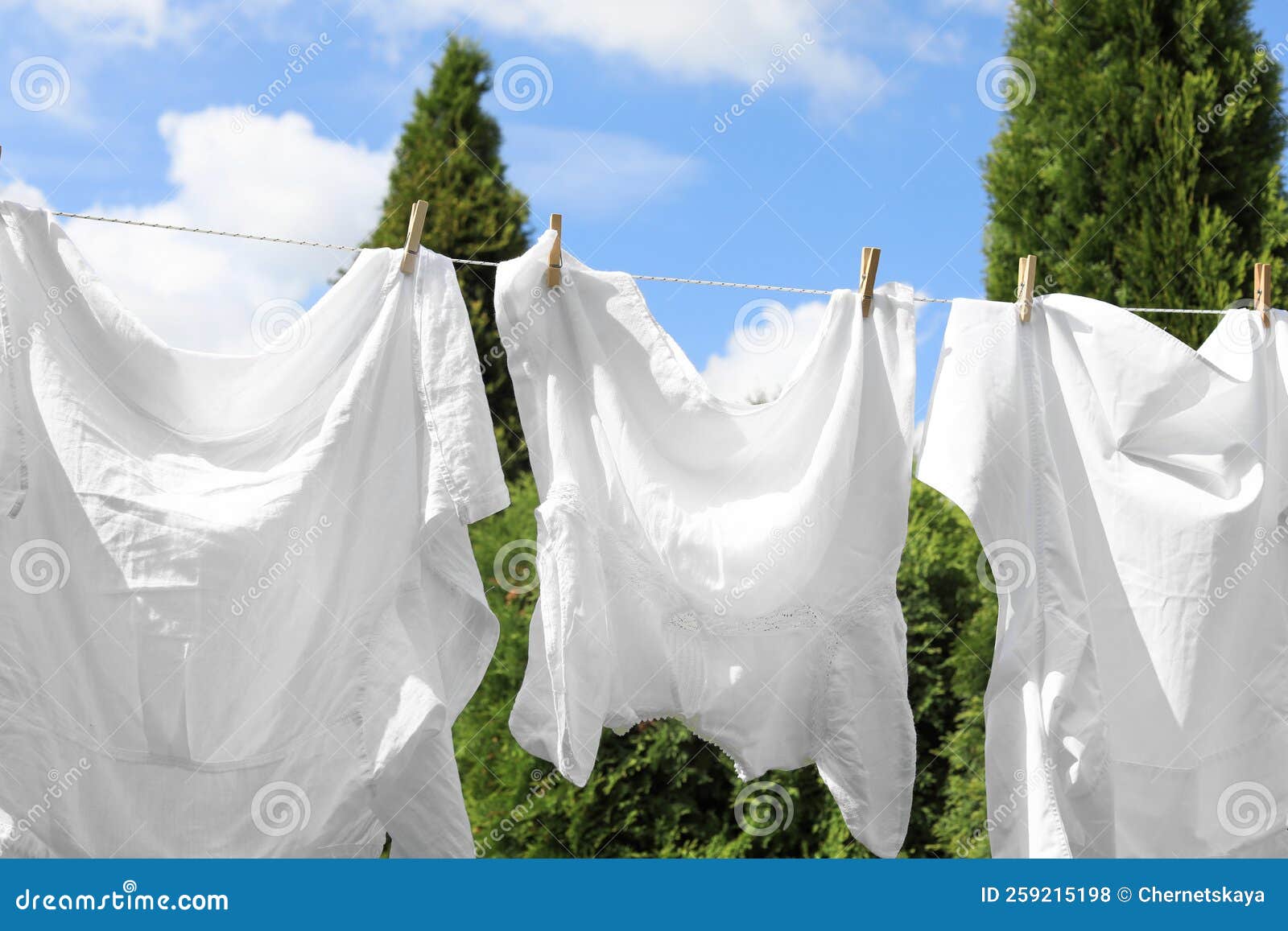 Clean Clothes Hanging on Washing Line Outdoors. Drying Laundry Stock ...