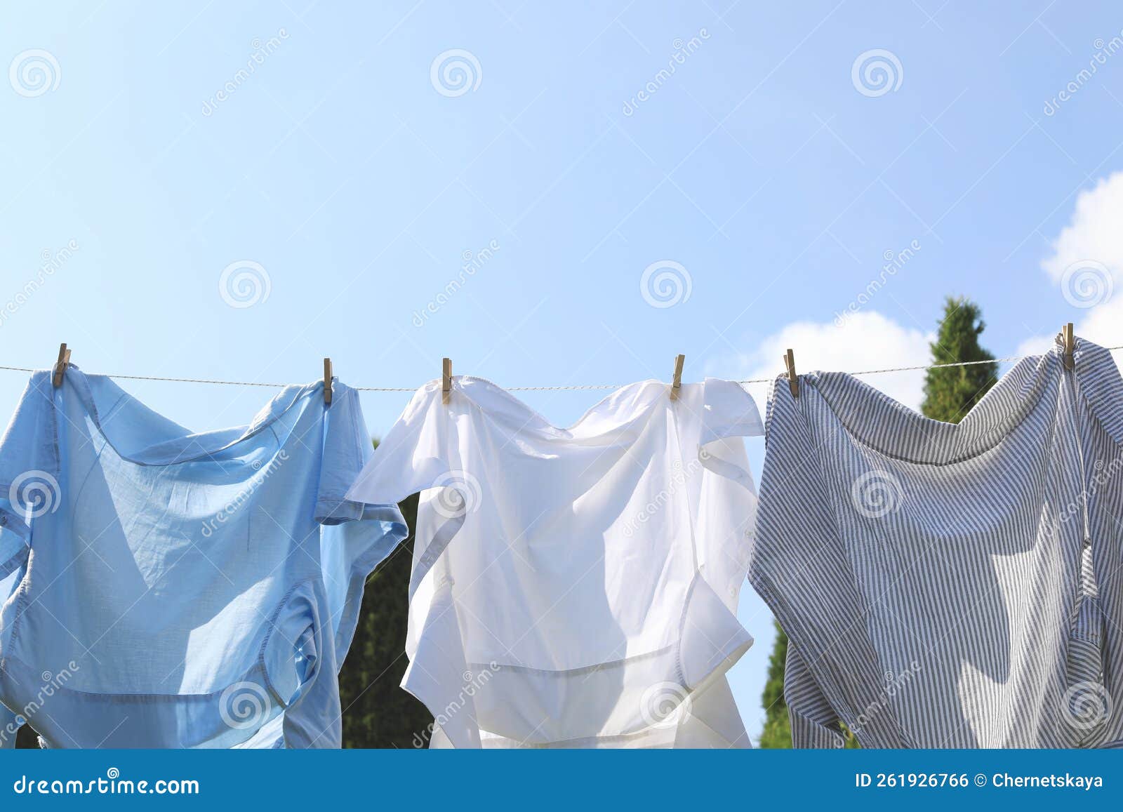 Clean Clothes Hanging on Washing Line Outdoors. Drying Laundry Stock ...