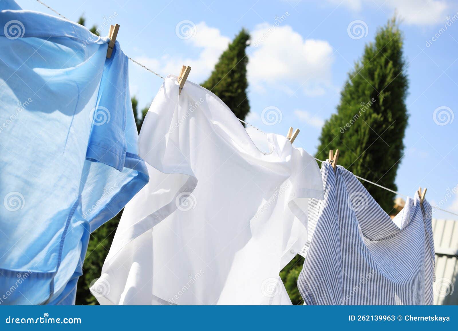 Clean Clothes Hanging on Washing Line Outdoors. Drying Laundry Stock ...