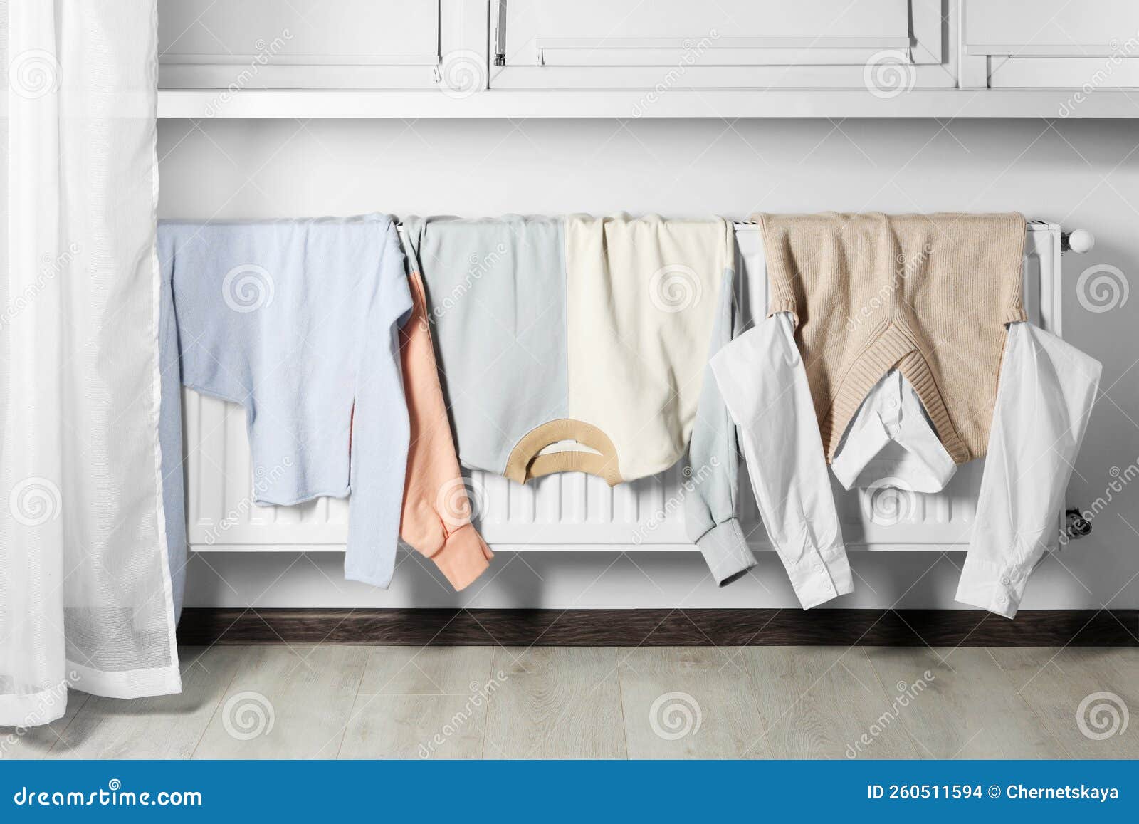Clean Clothes Hanging on White Radiator in Room Stock Photo - Image of ...