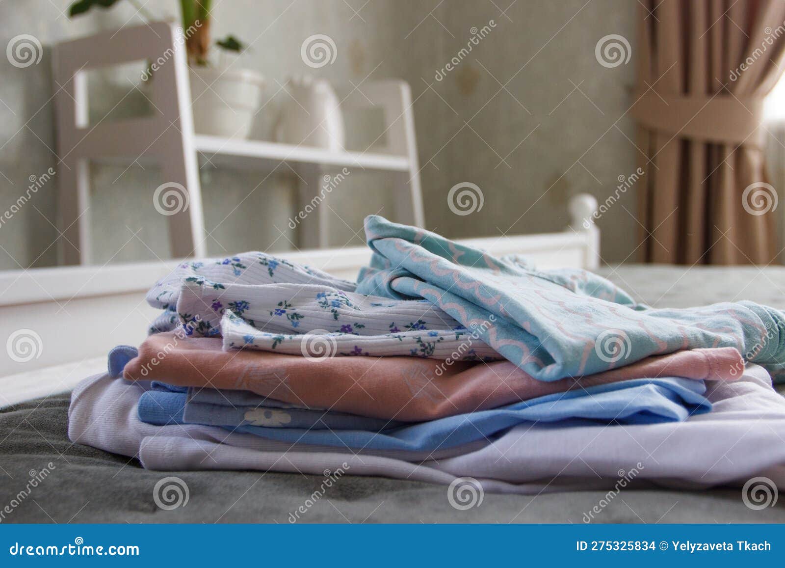Clean Colored Clothes on the Bed in a Bedroom, Blurred Background Stock ...