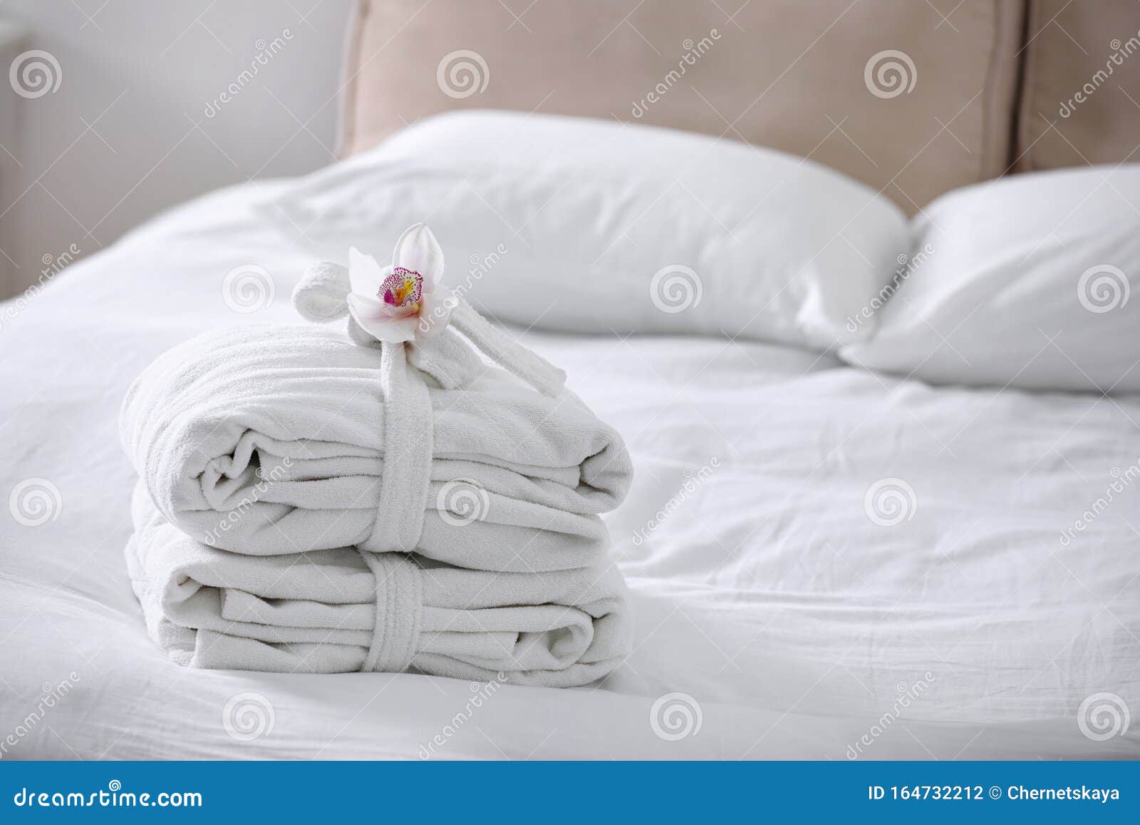 Clean Folded Bathrobes on Bed in Room Stock Photo - Image of cotton ...