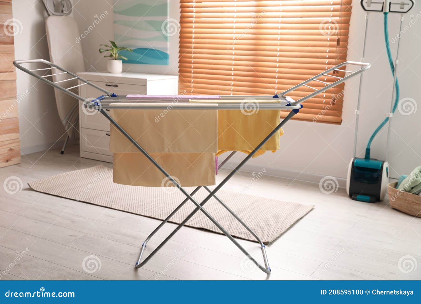 Clean Laundry Hanging on Drying Rack Indoors Stock Photo - Image of ...