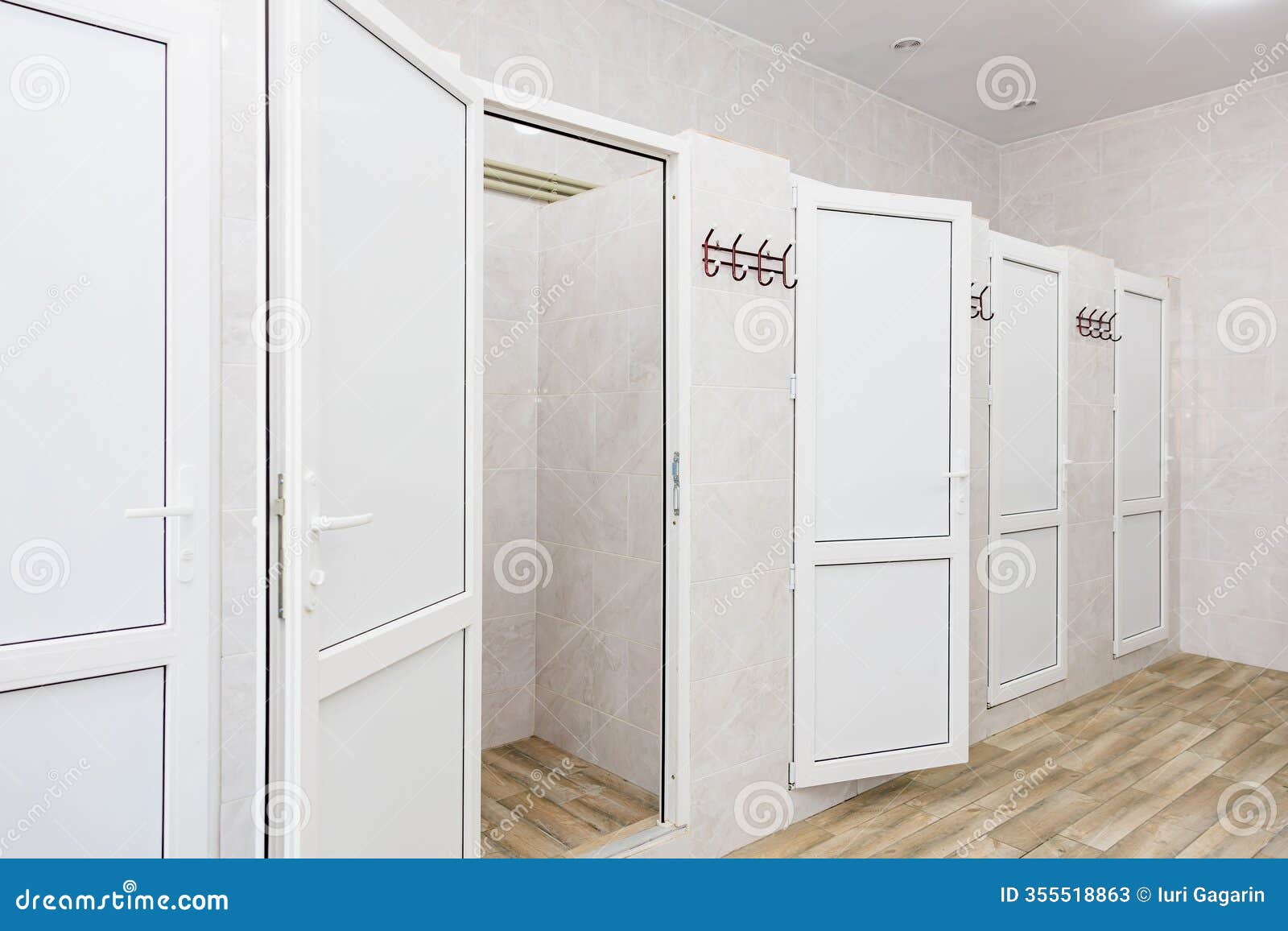 Clean Public Bathroom Stalls with Open White Doors and Tiled Walls ...
