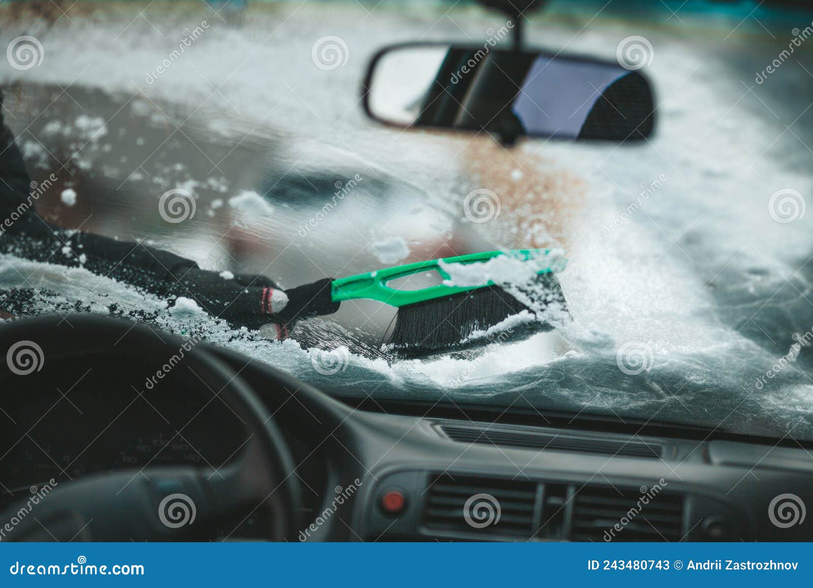 Clean Snow and Ice on the Windshield with a Brush in a Snow Storm Stock ...