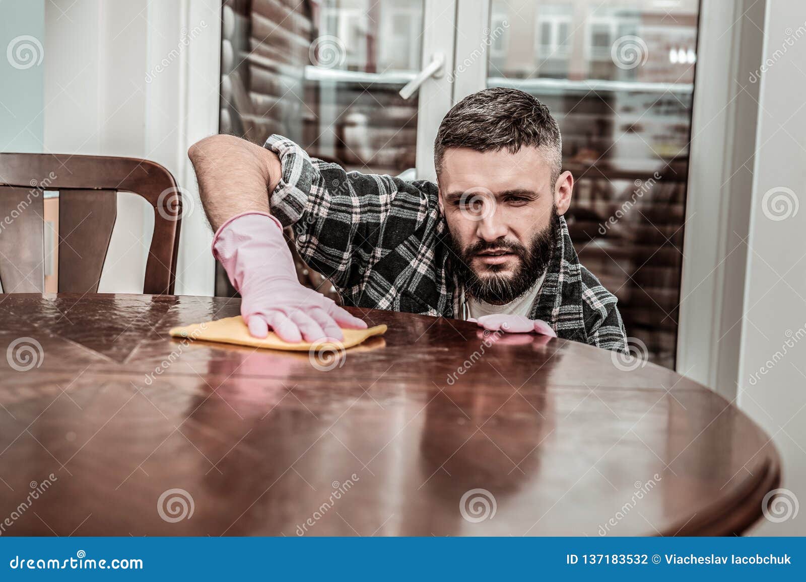 Pleasant Nice Man Cleaning the Table in the House Stock Photo - Image ...