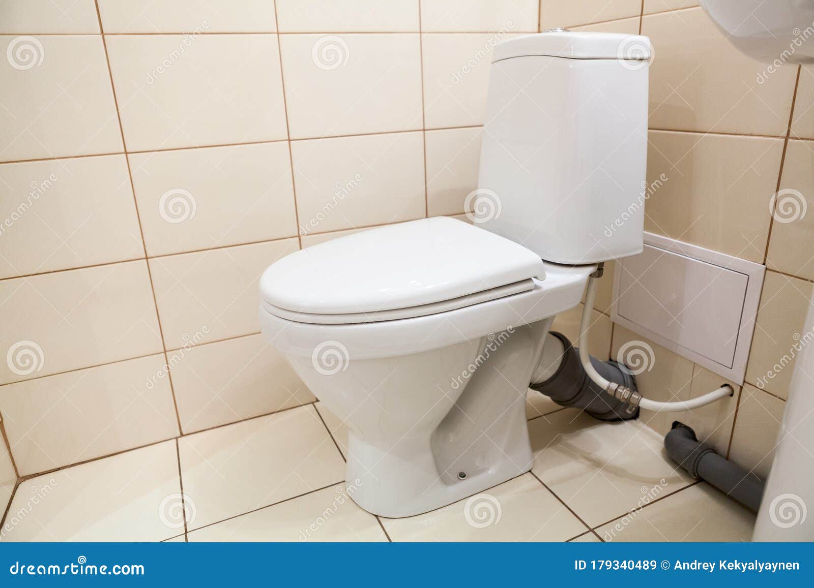 Clean White Bathroom Toilet with the Lid Closed, Side View Stock Image ...