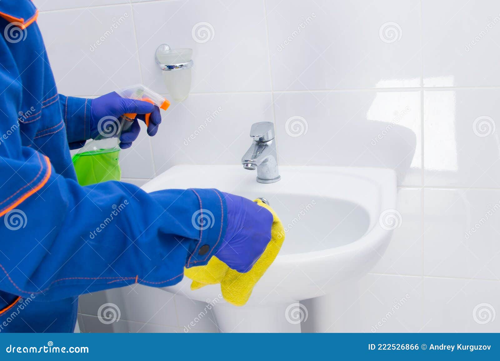 Cleaning the Bathroom, Disinfecting the Sink with a Cloth and a Special ...